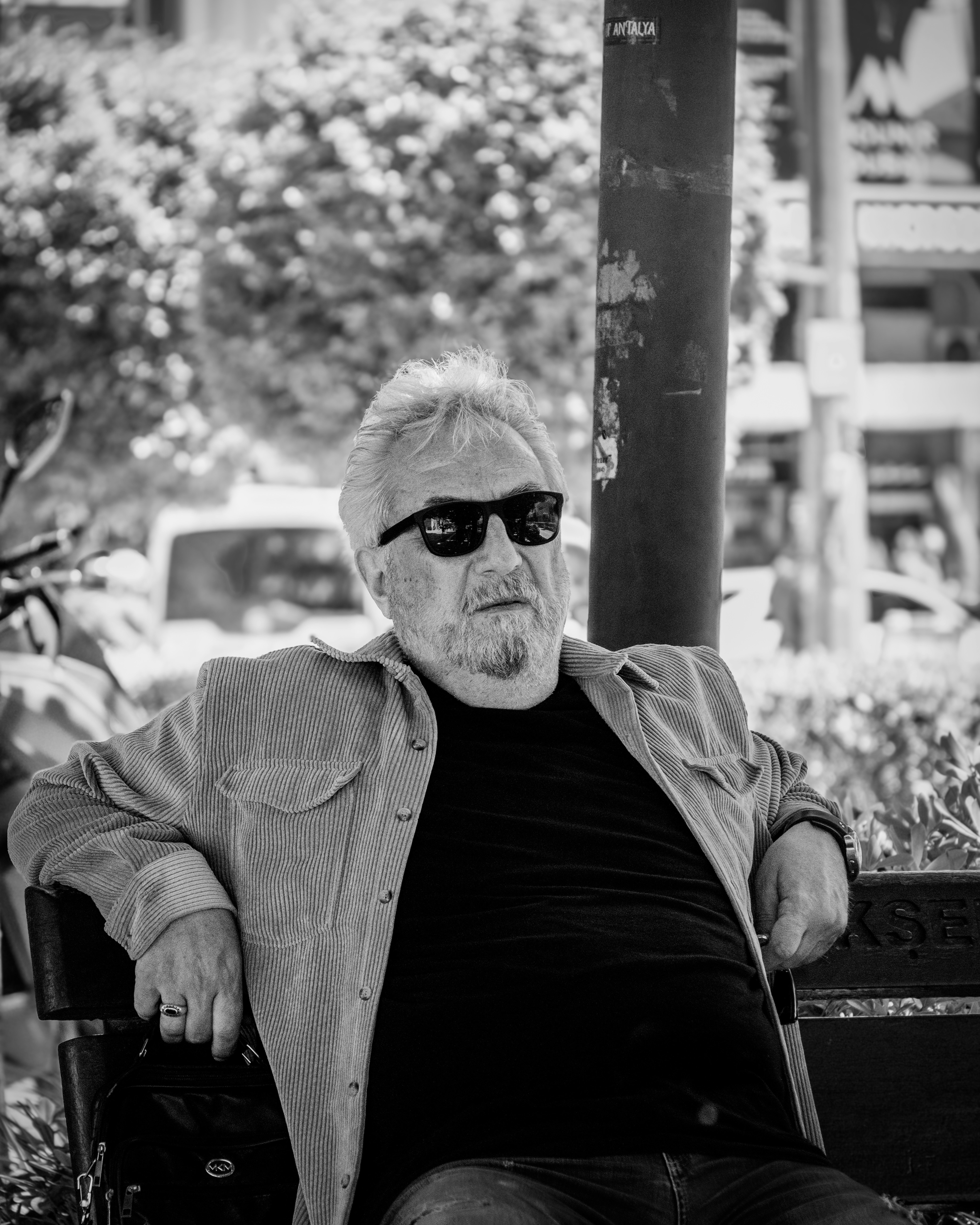 Relaxed Portrait in Shade: An Armchair Moment Under City Light