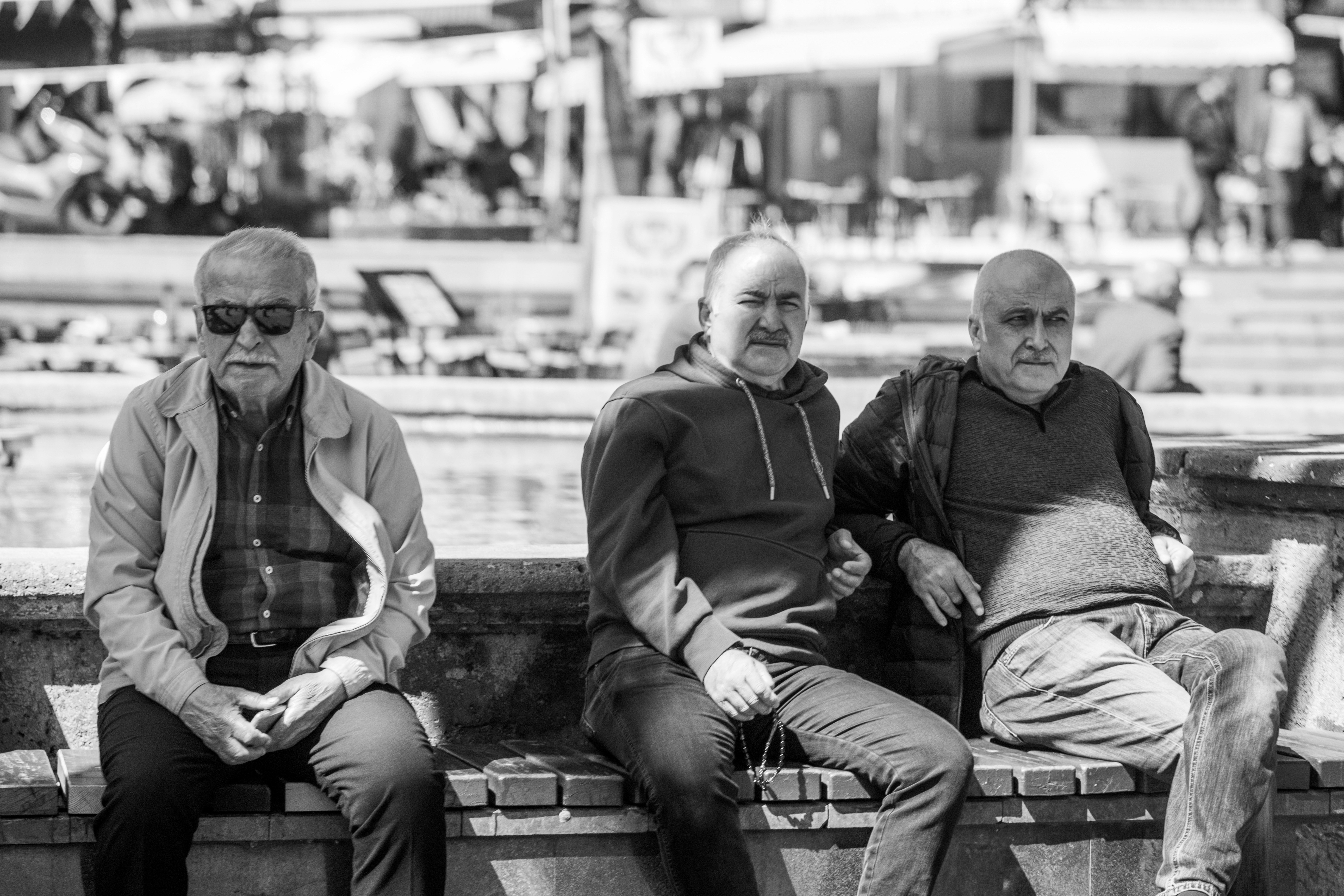 Three Somber Companions by the Park Bench