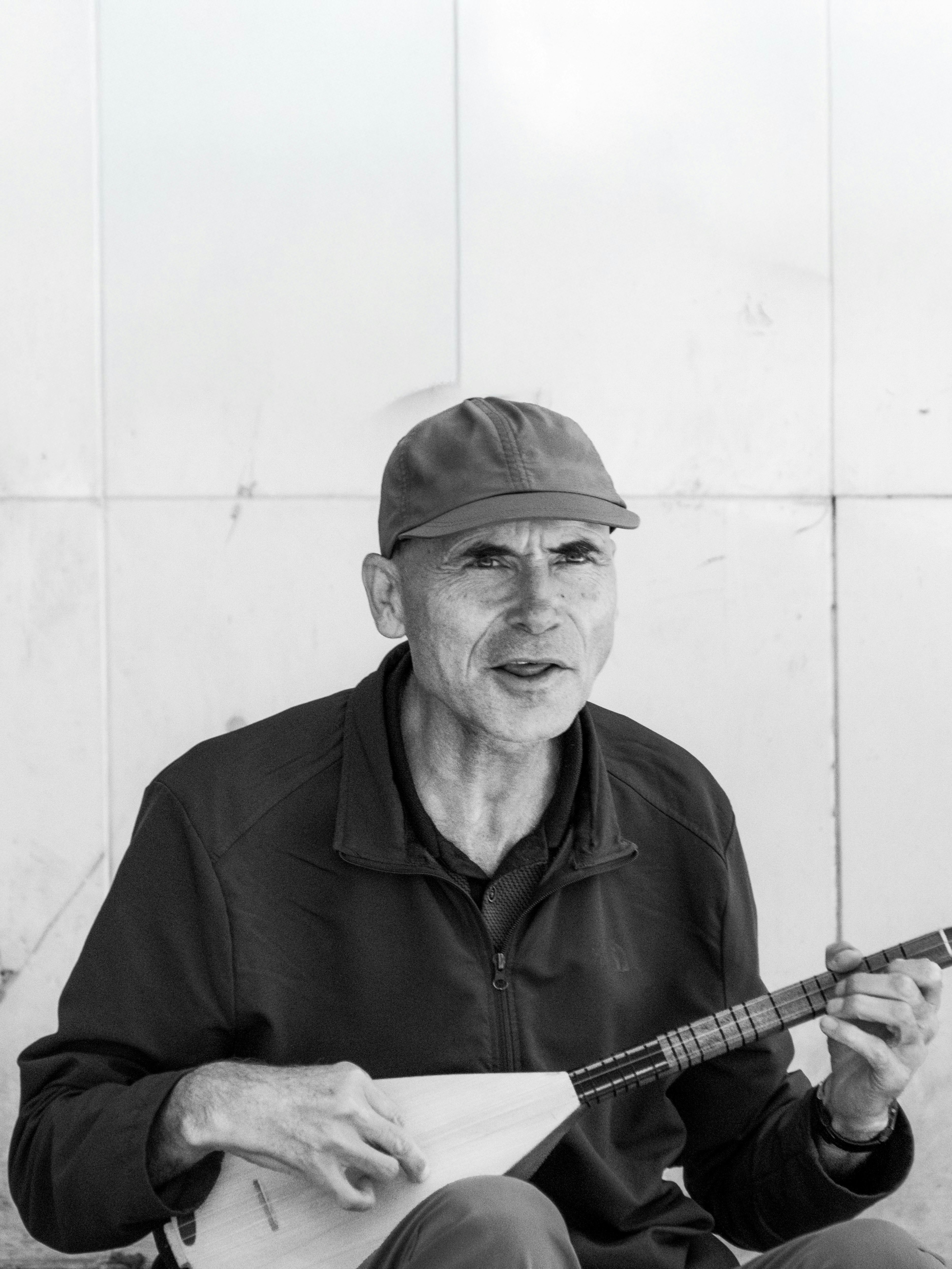 Stringed Quiet: A Wind-Curved Portrait of a Musician