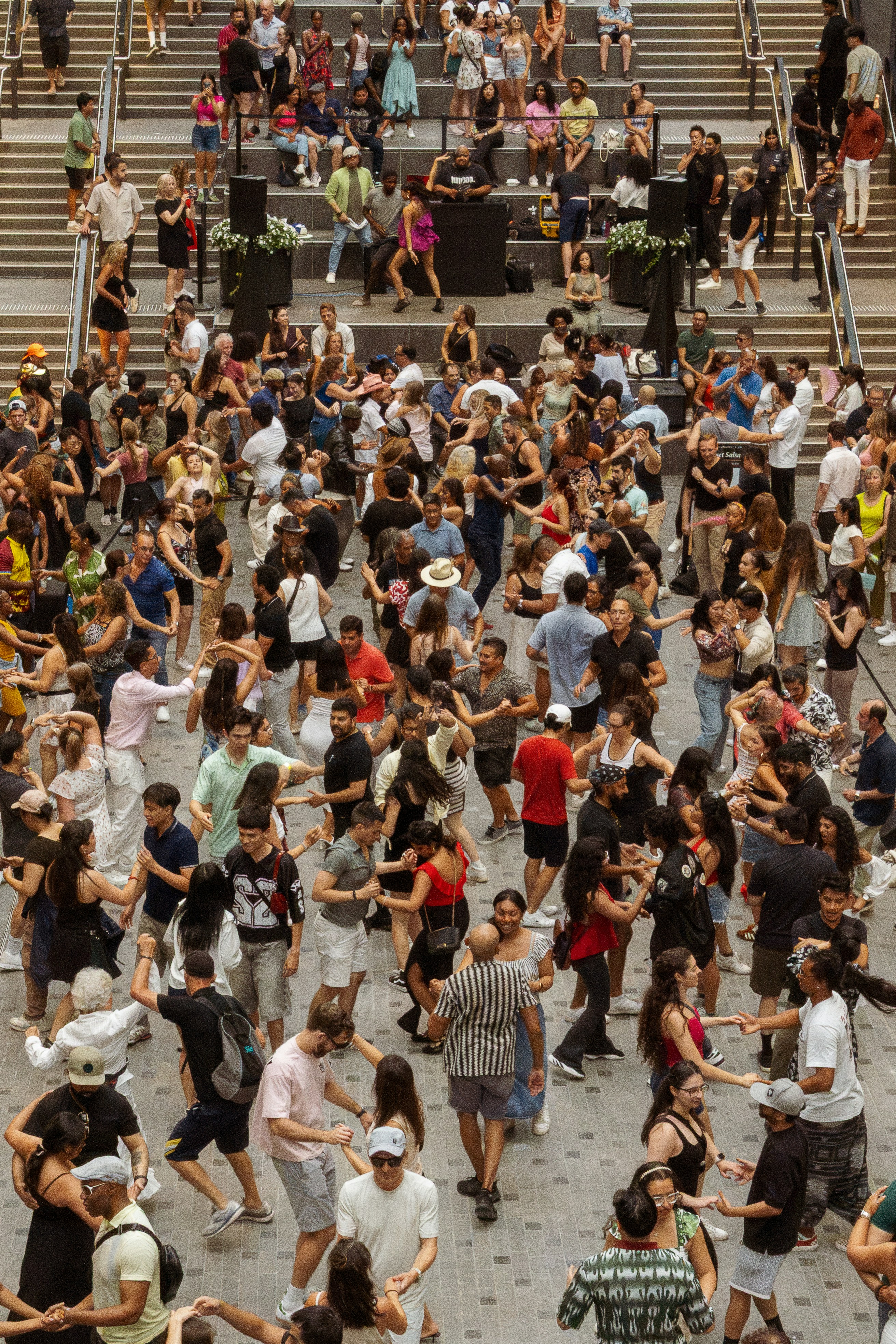 A Sea of Dancers in a Grand Urban Atrium