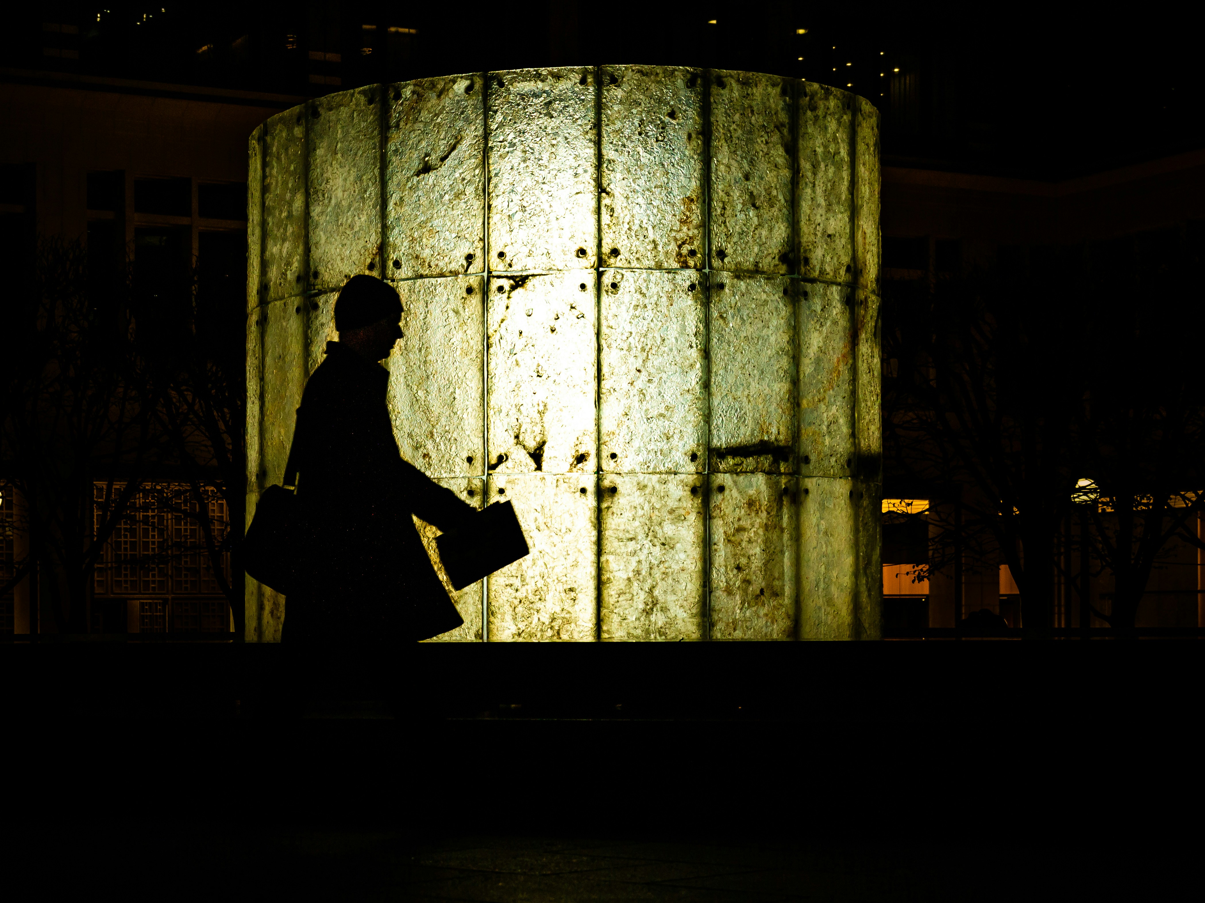 Silhouette in Front of a Lantern-lit Cylindrical Wall