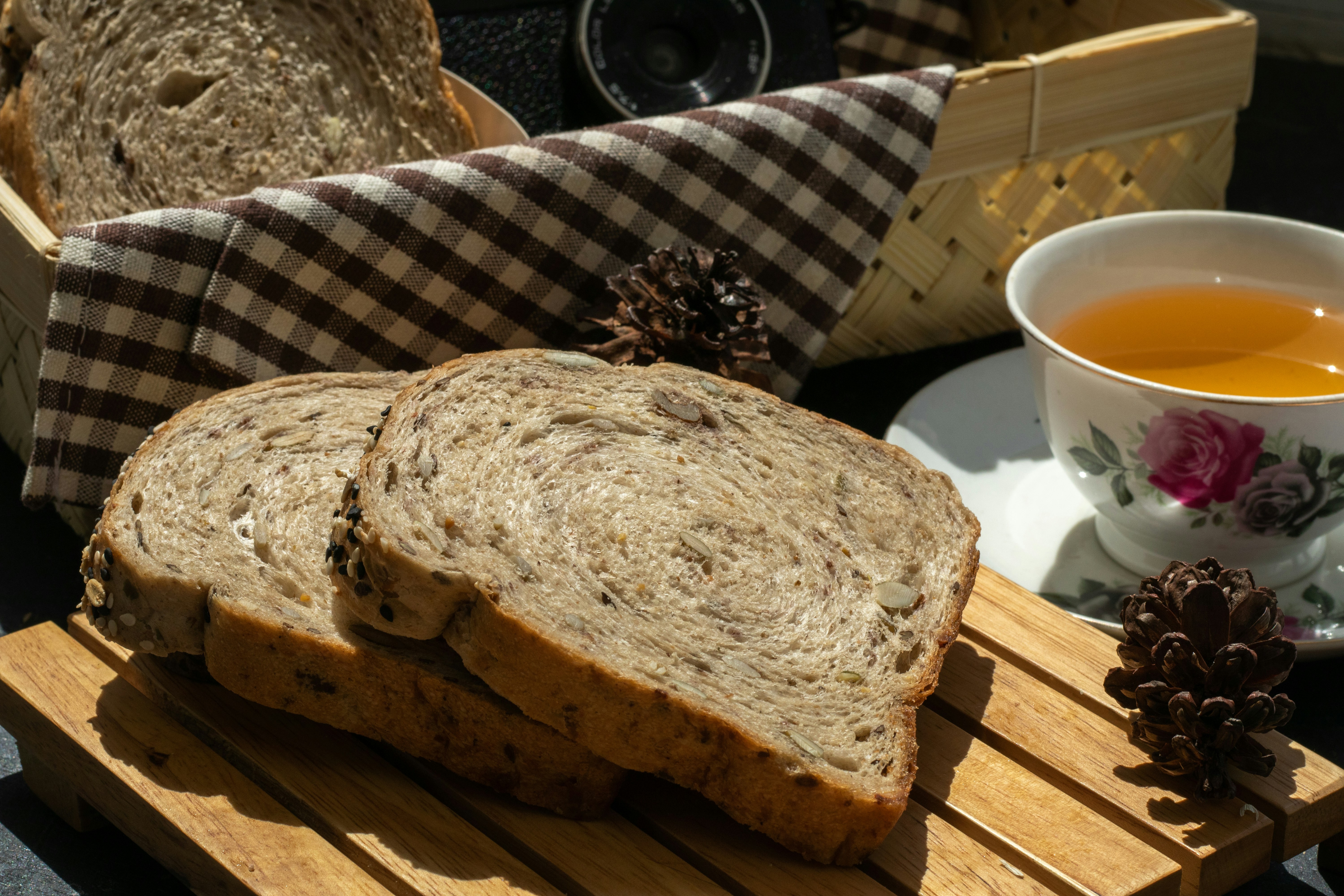Sunlit Slices: Rustic Banana-Seed Bread on a Wooden Board