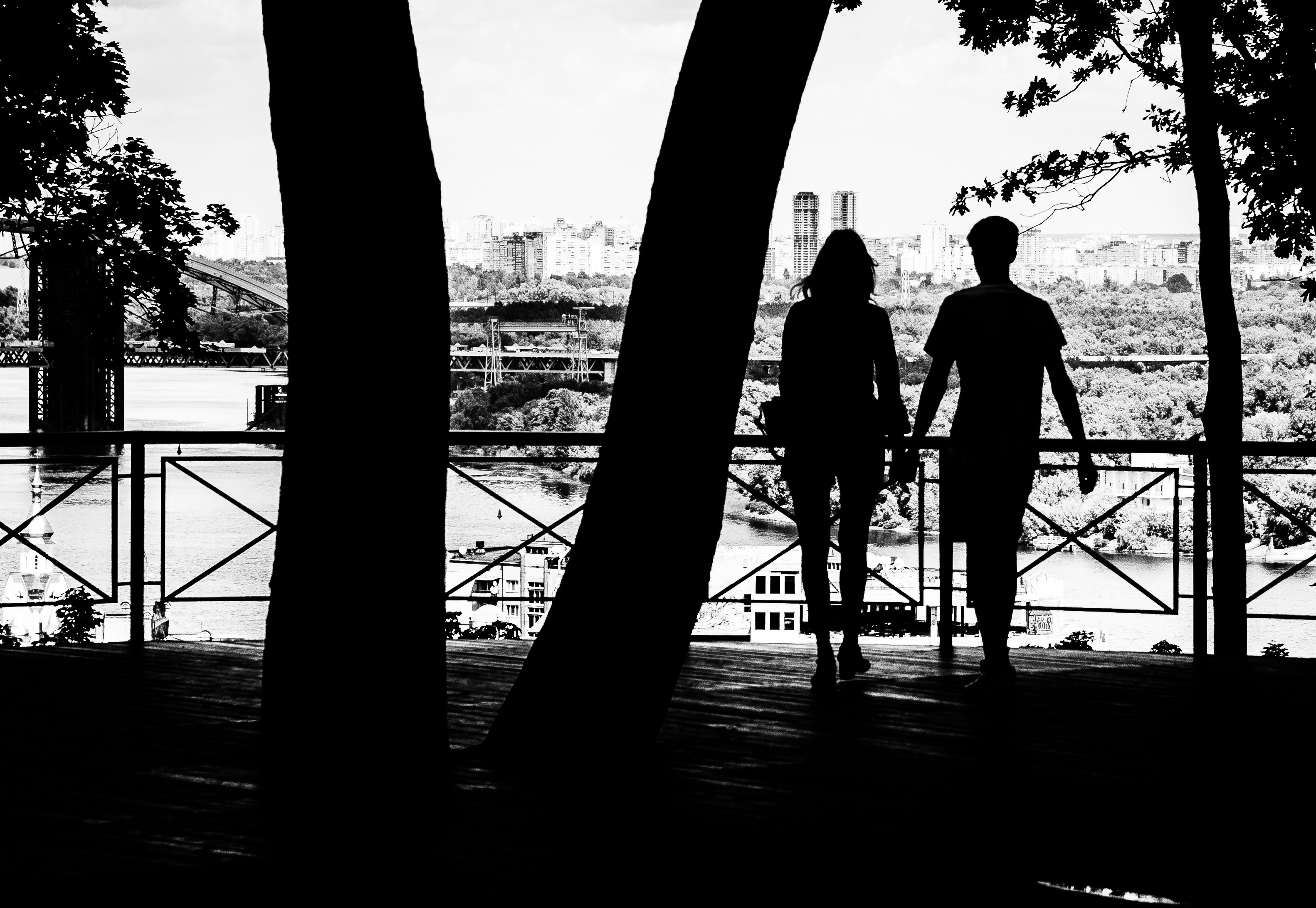 Silhouetted Travelers in a Waterfront Park