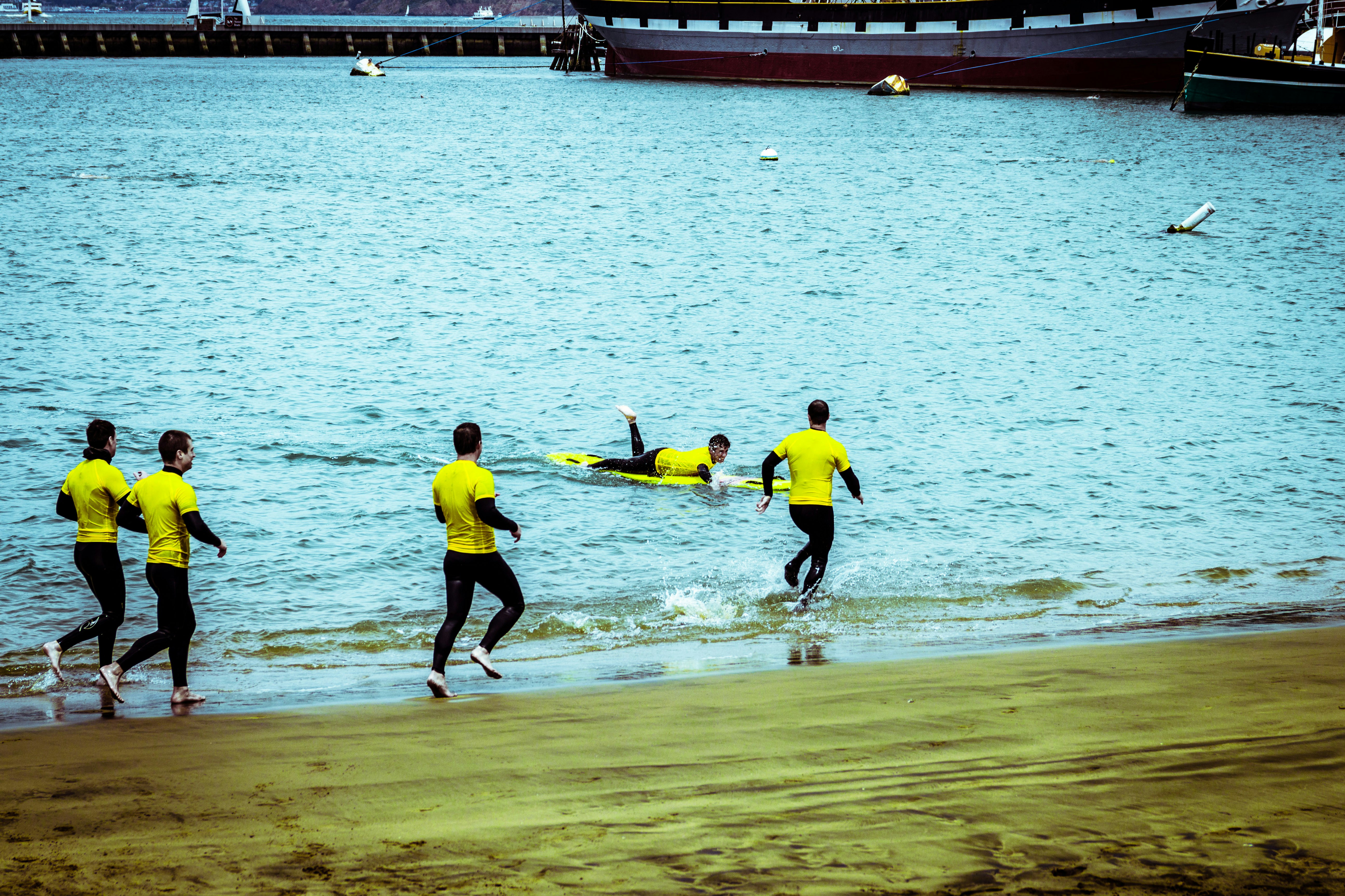 Yellow-shirted Crew Converging on Shoreline Splash