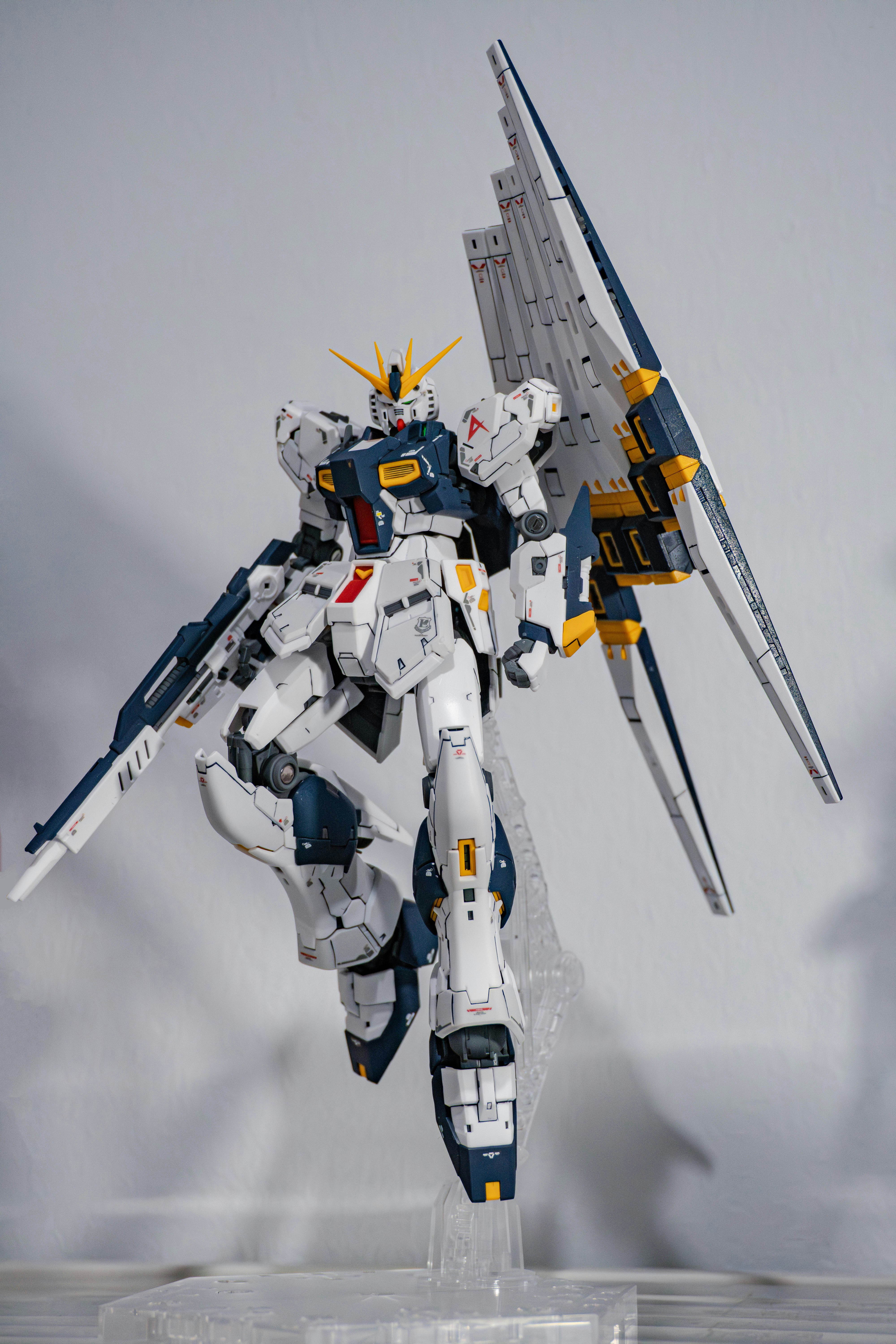Gundam in flight: mechanical dagger against a pale backdrop