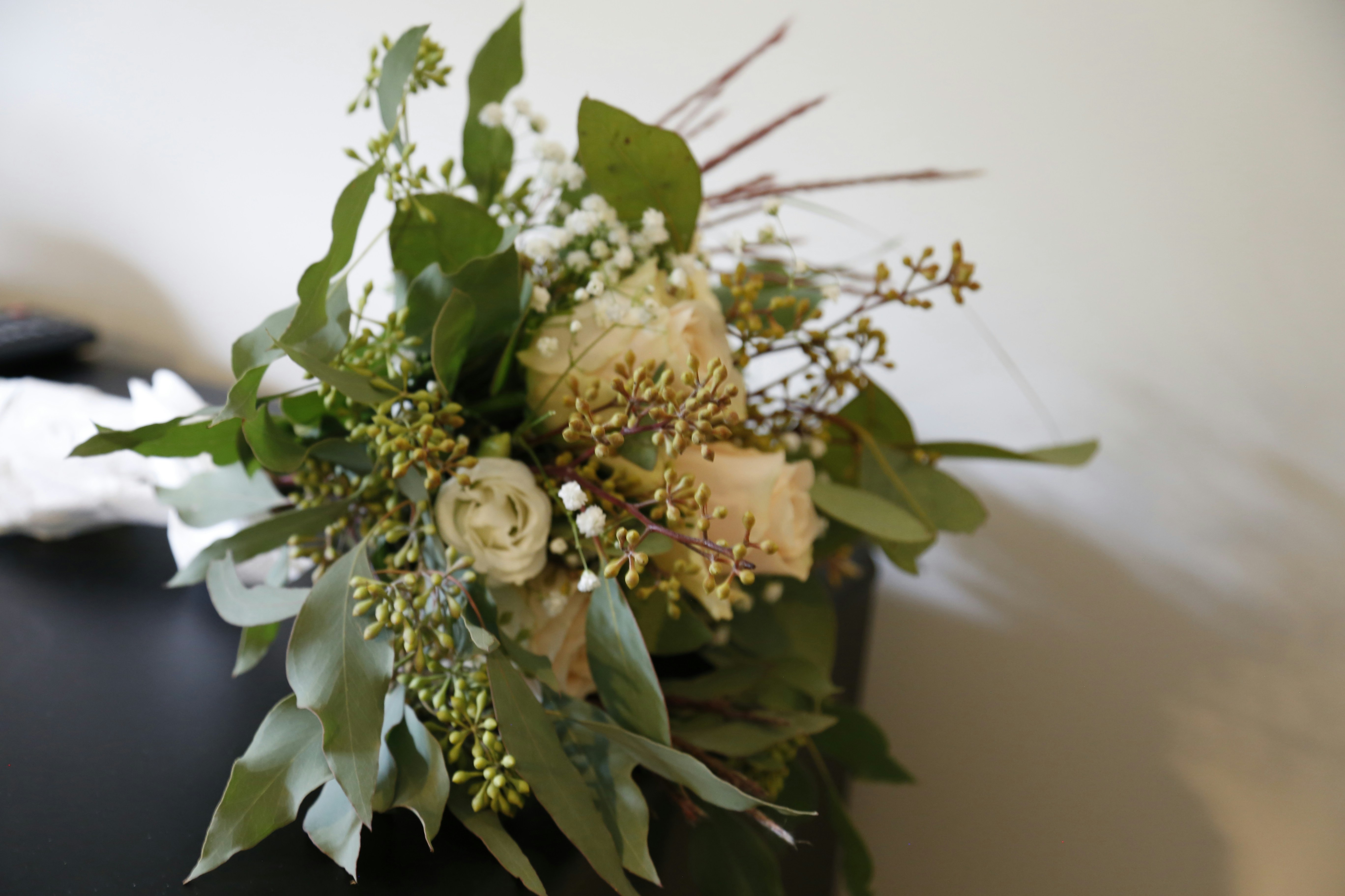 Bouquet in Soft Focus: White Roses and Greenery on a Quiet Table