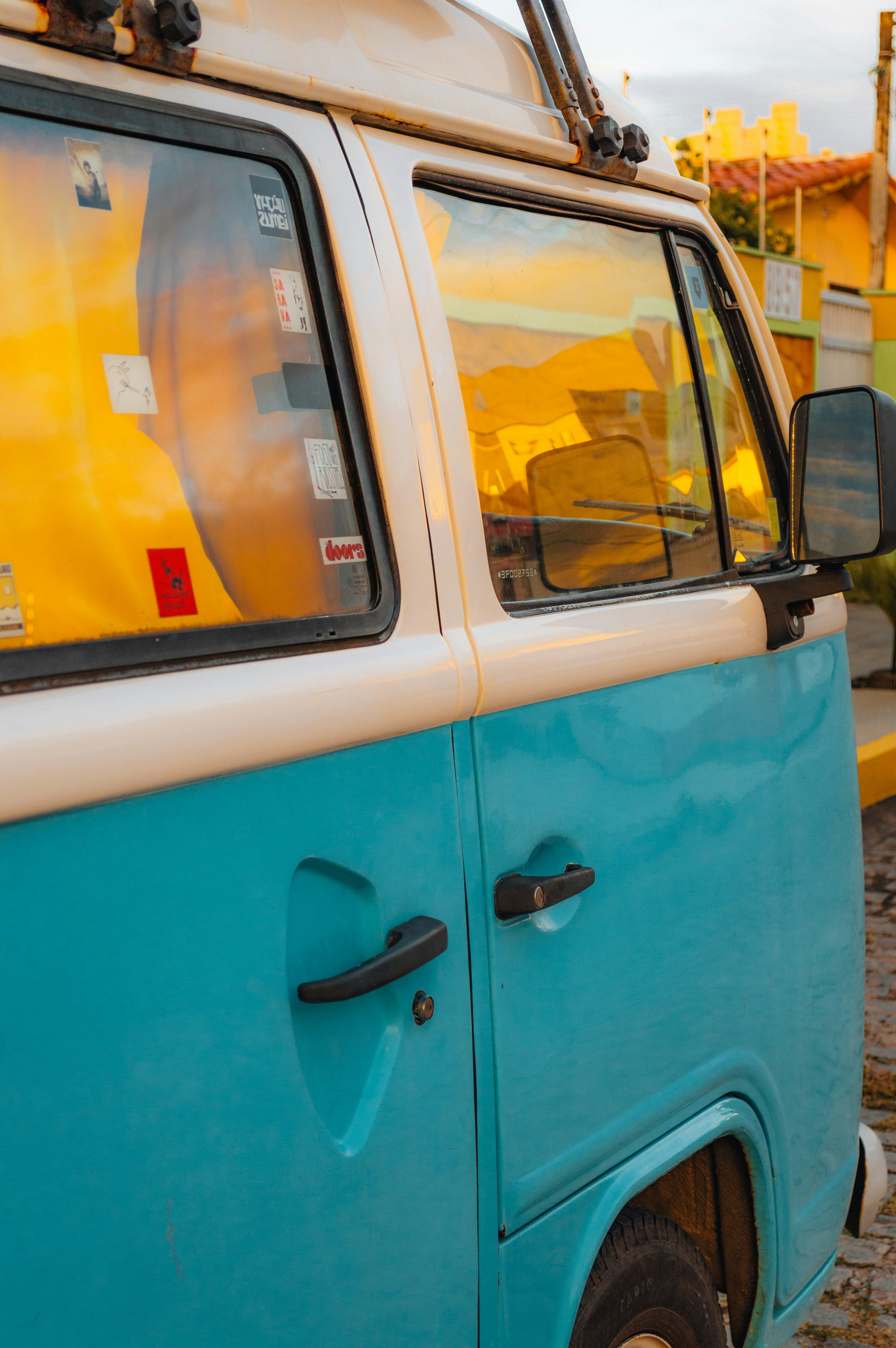 Teal van at golden hour: a streetfront portrait in sunlit color