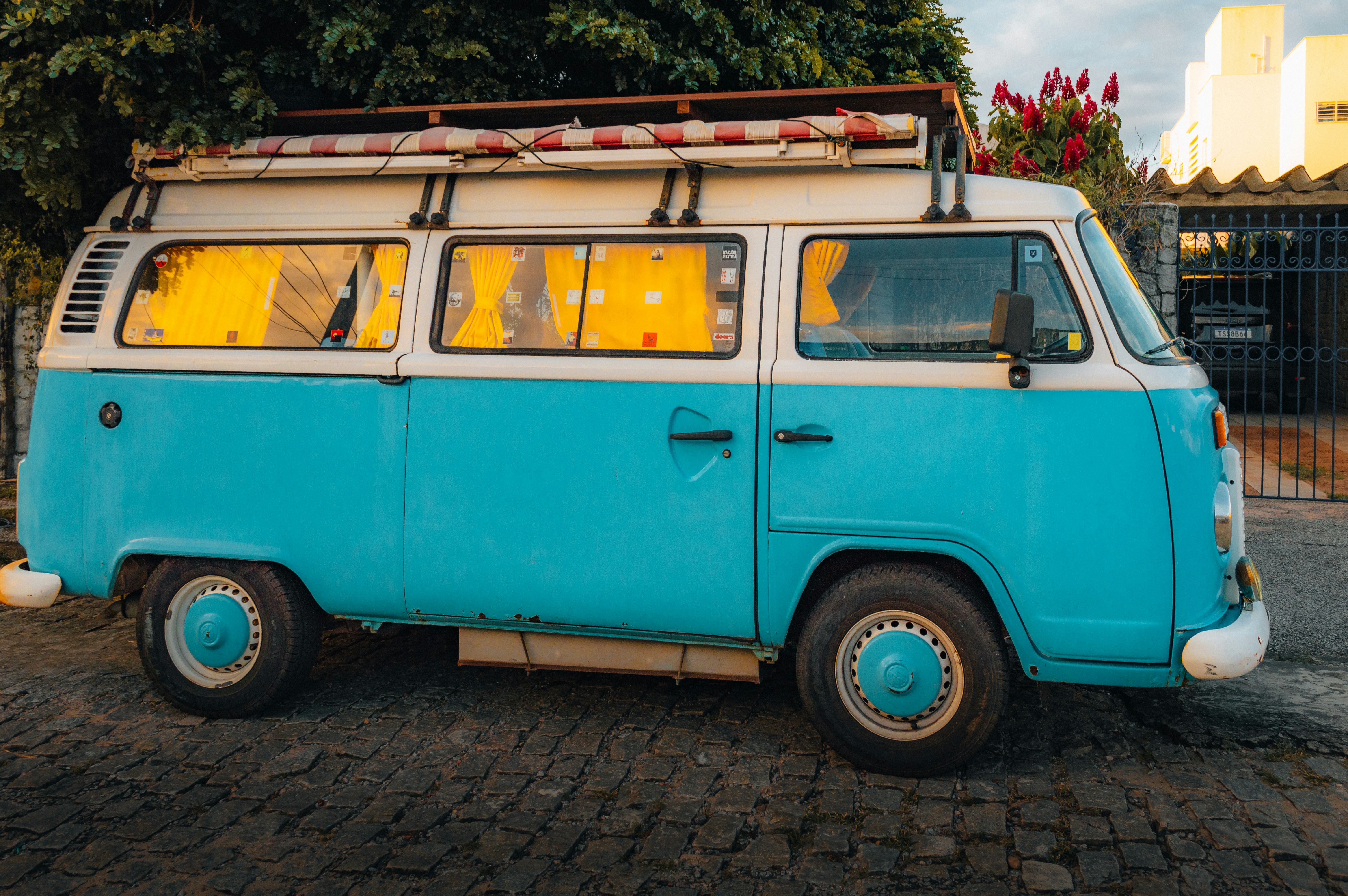 A Turquoise Vintage Van Resting Quietly on Cobblestones