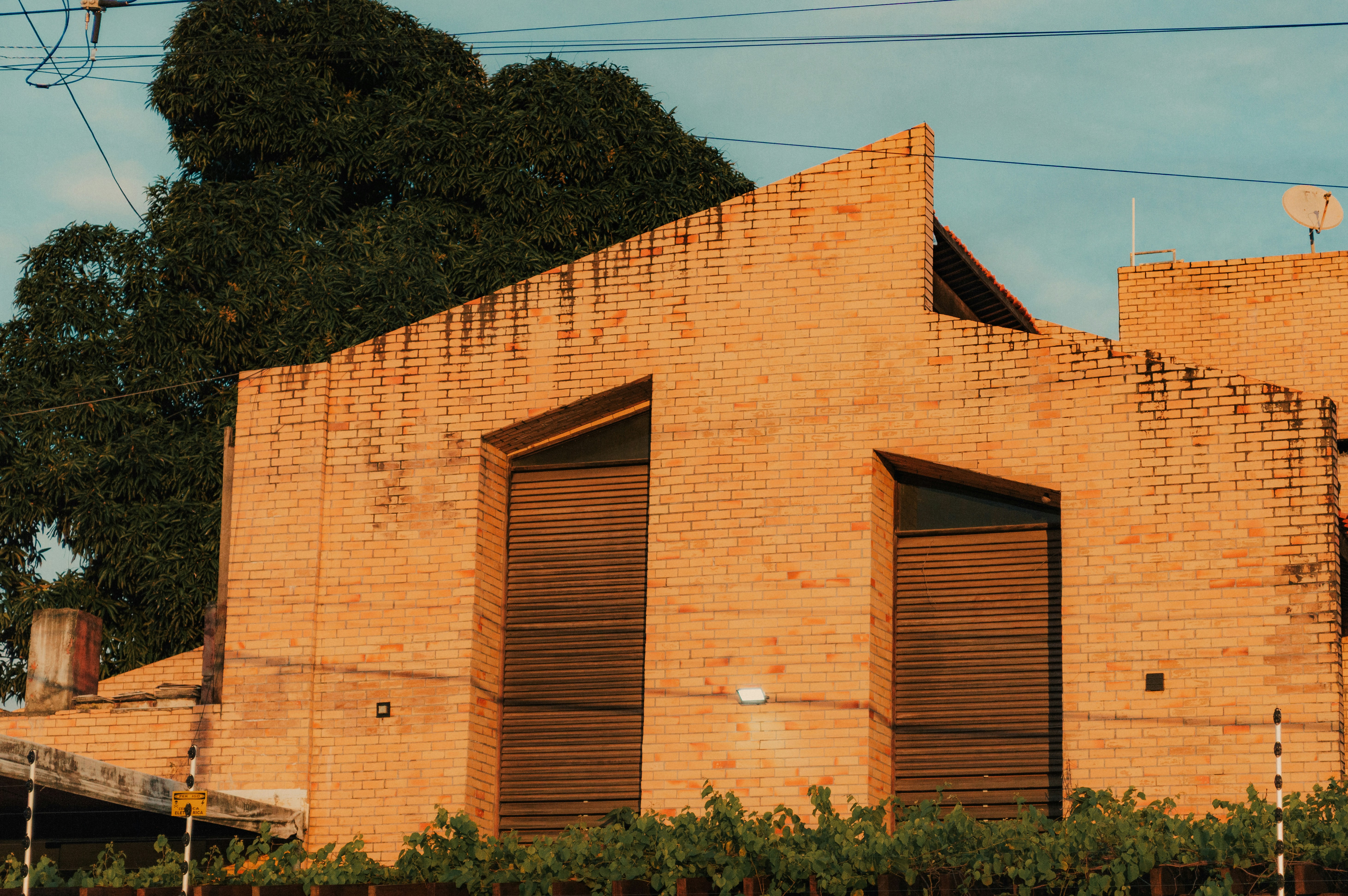 Brick Sunlit Facade with Propped Gable and Shuttered Openings