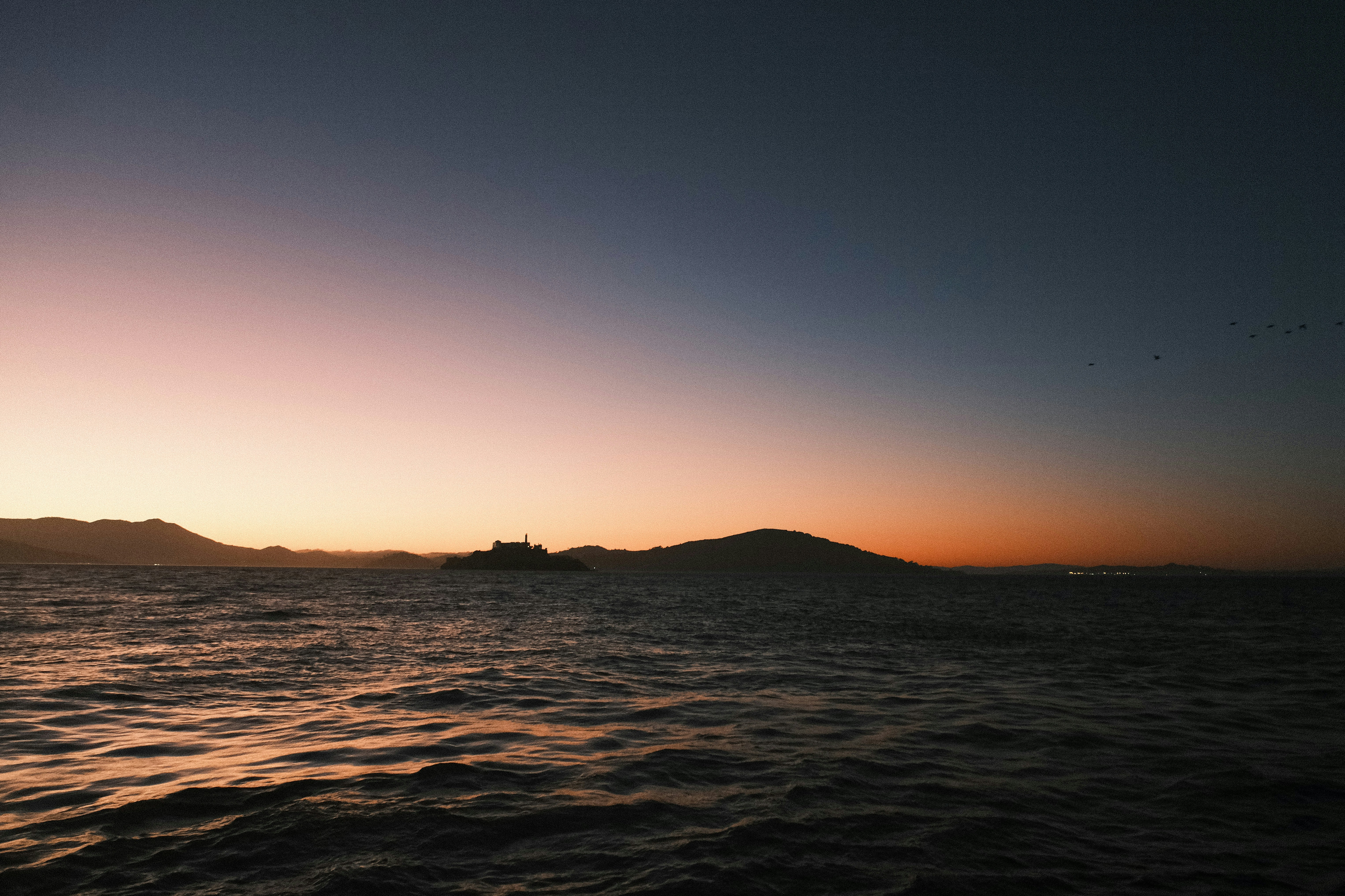 Dusk Over a Quiet Sea: Horizon Silhouette and Gentle Waves