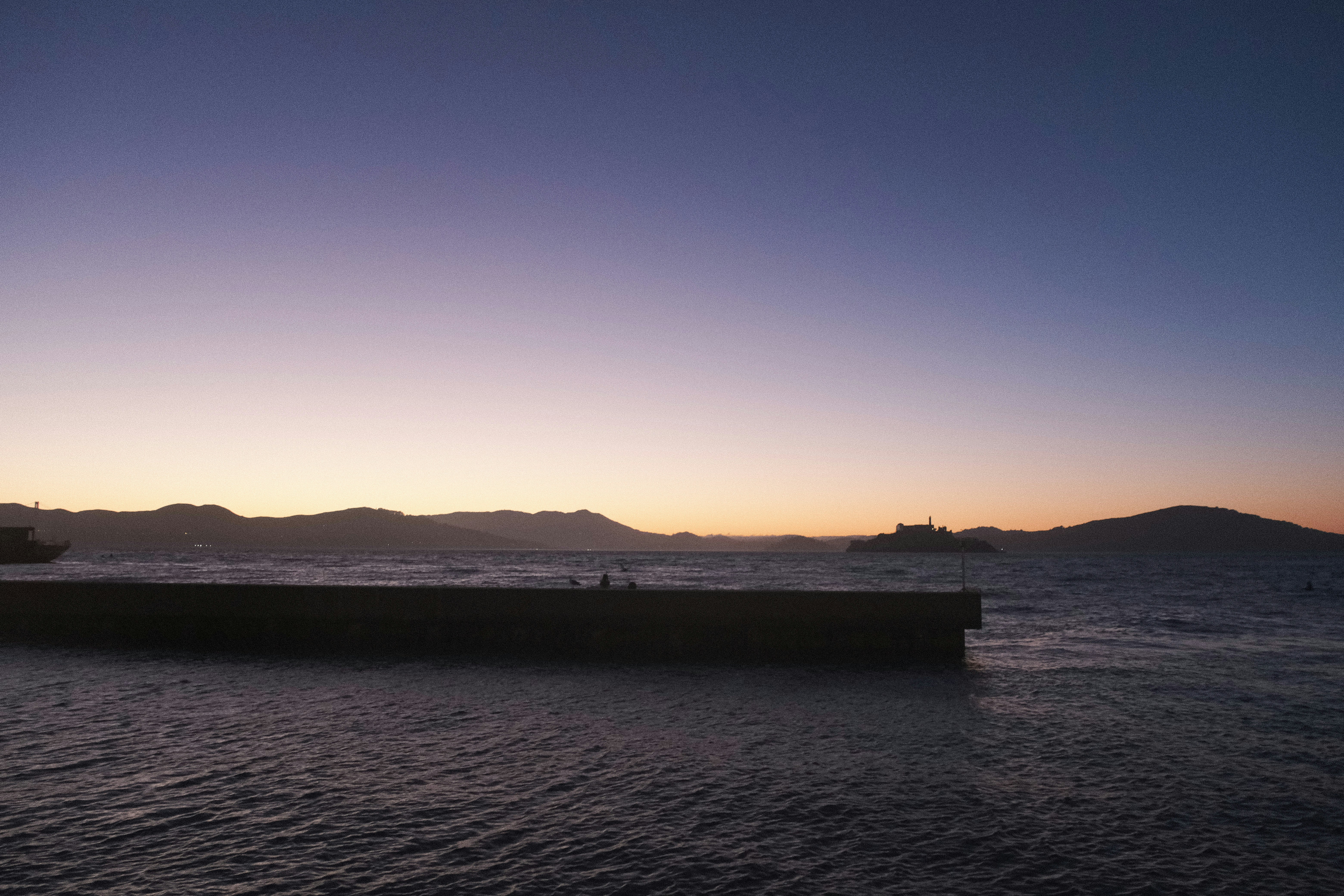 Dusk on the Pier: Quiet Horizon Over Quiet Seas