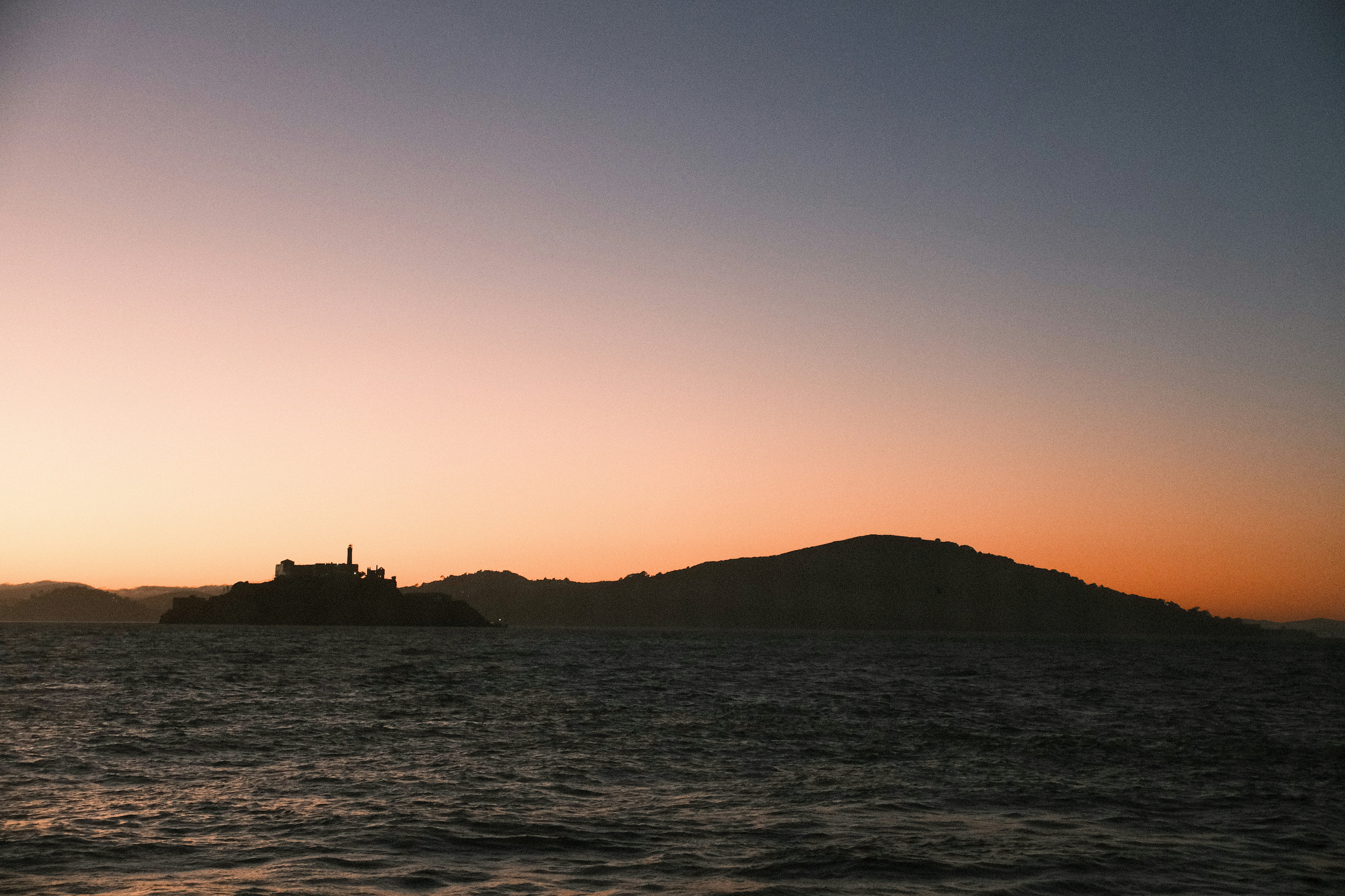 Dusk Over a Quiet Bay: The Island Silhouette at Sunset