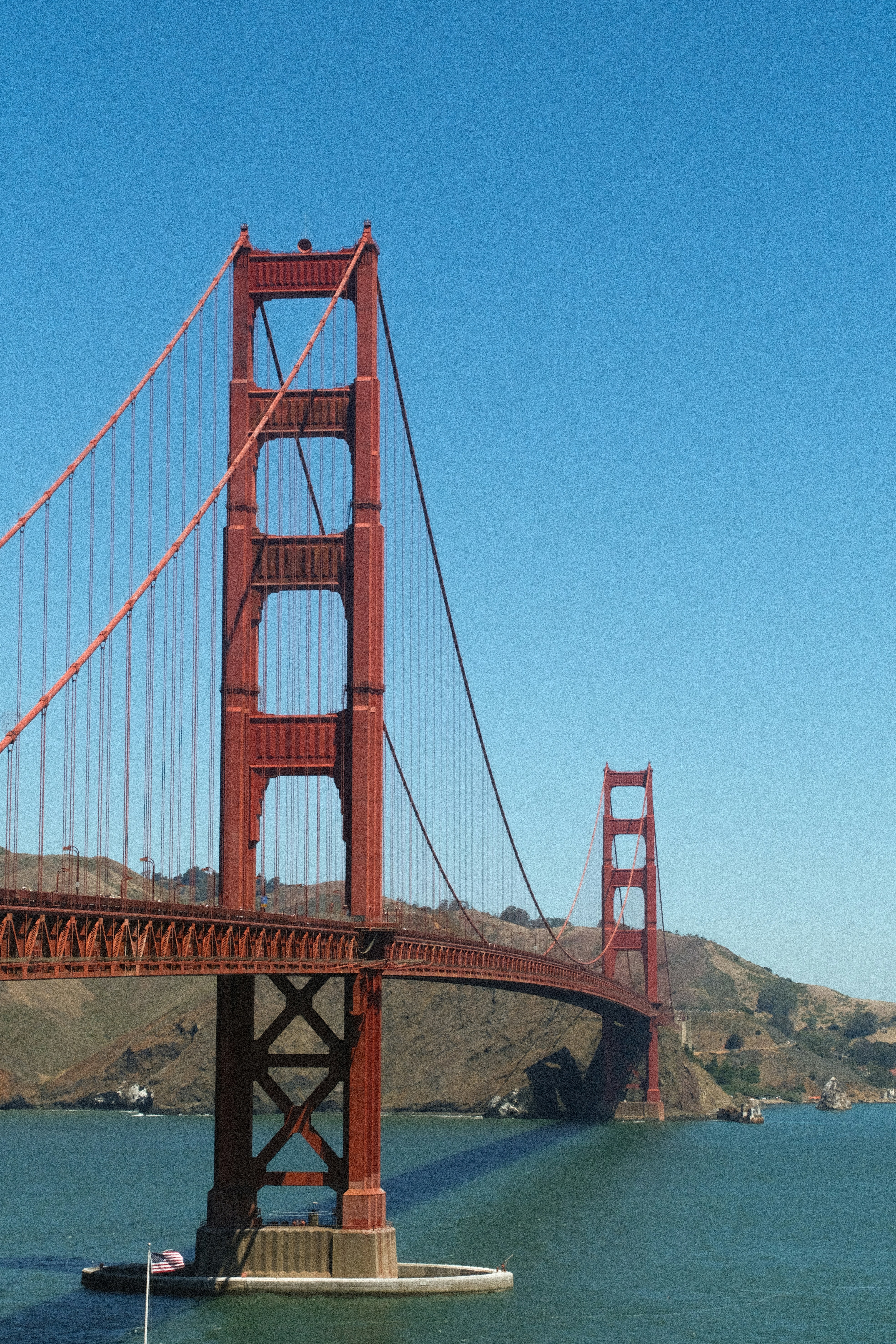 Red Iron Span: Golden Gate Arc Across a Calm Bay
