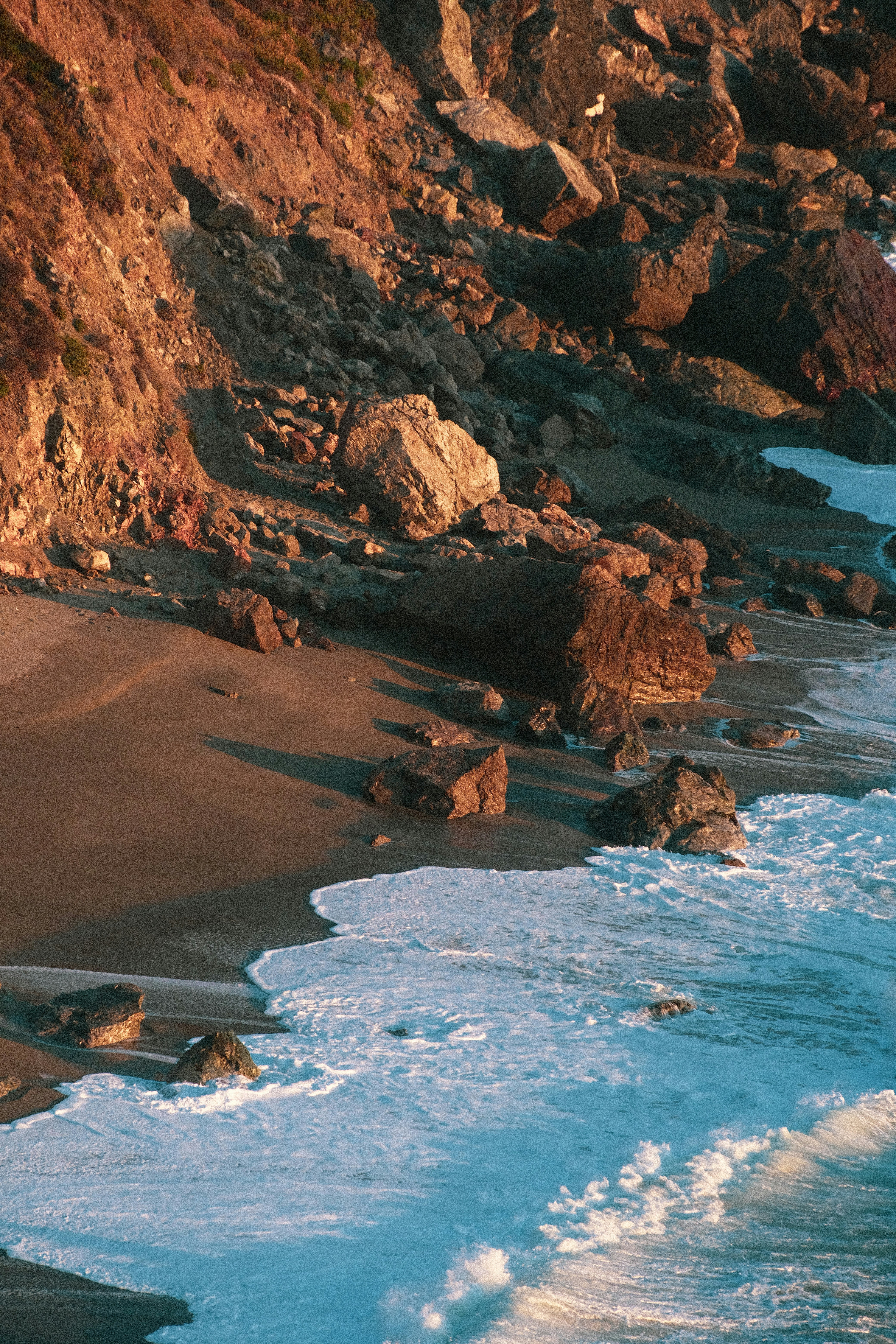 Sunlit Cliffs and Tidal Edge: A Coastal Palette of Rock and Sea