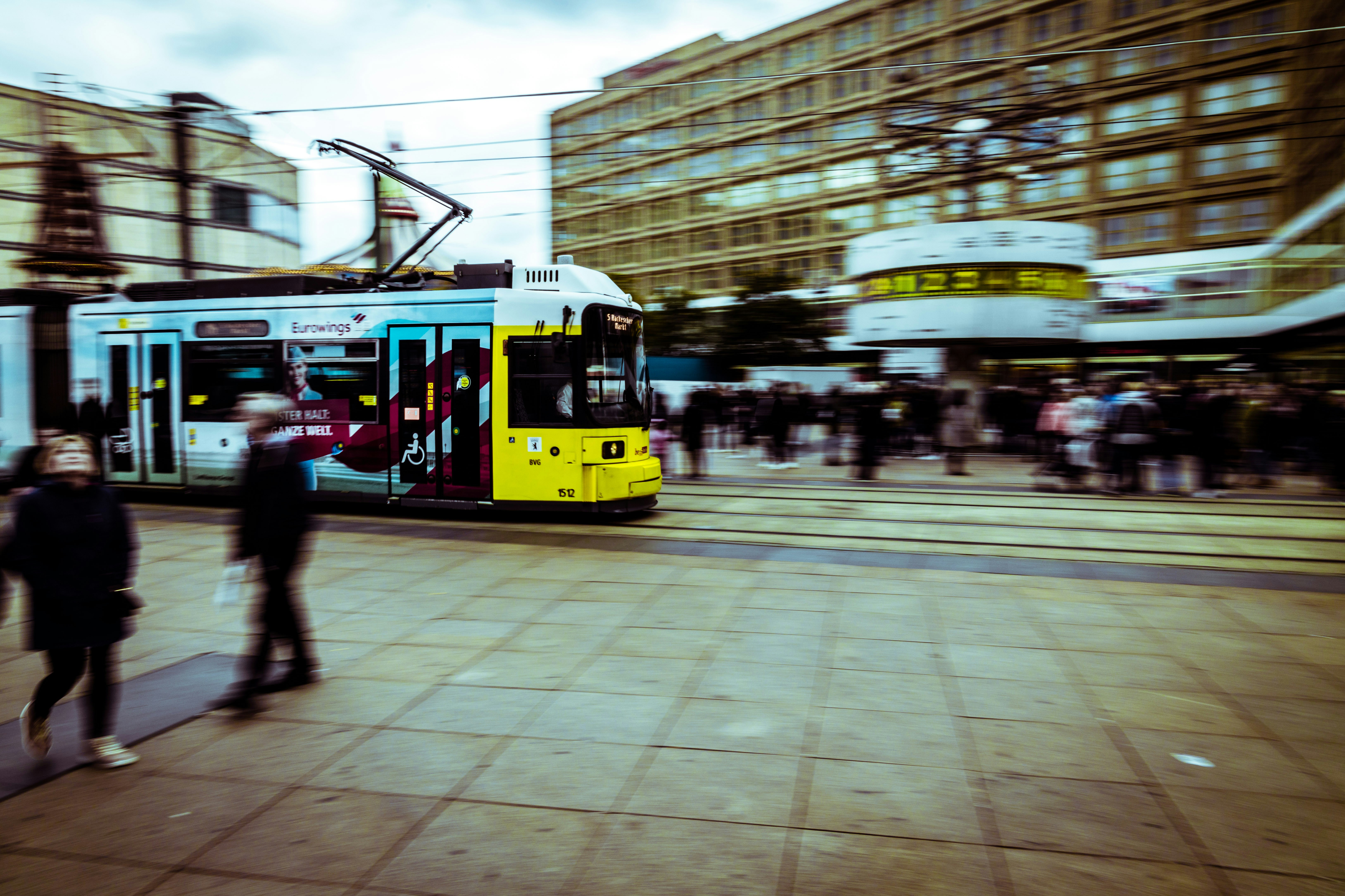 Urban Tram at Dusk: A Moment of Motion and Crowd Blur