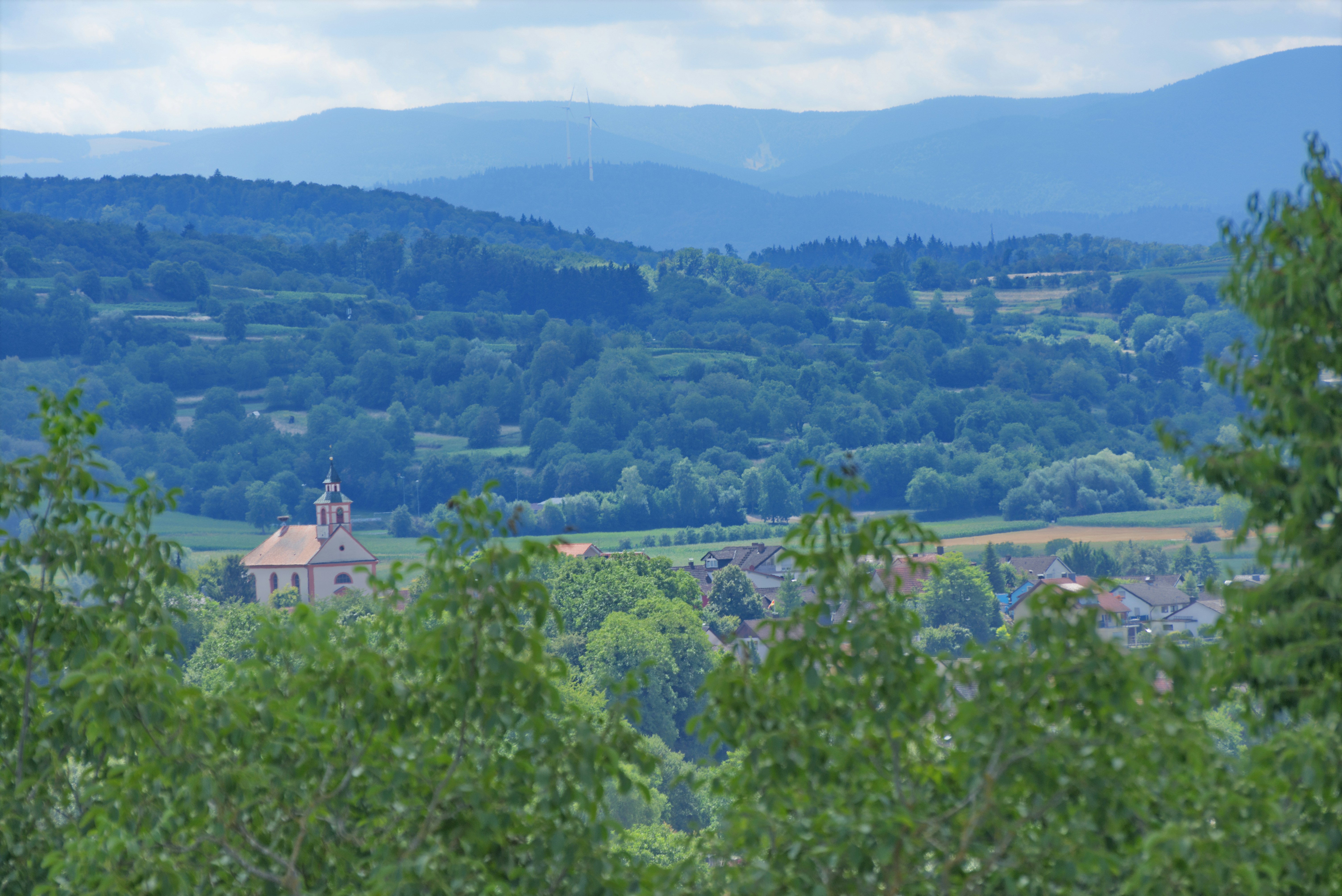 Quiet Hilltop Village Beneath a Layered Blue Ridge