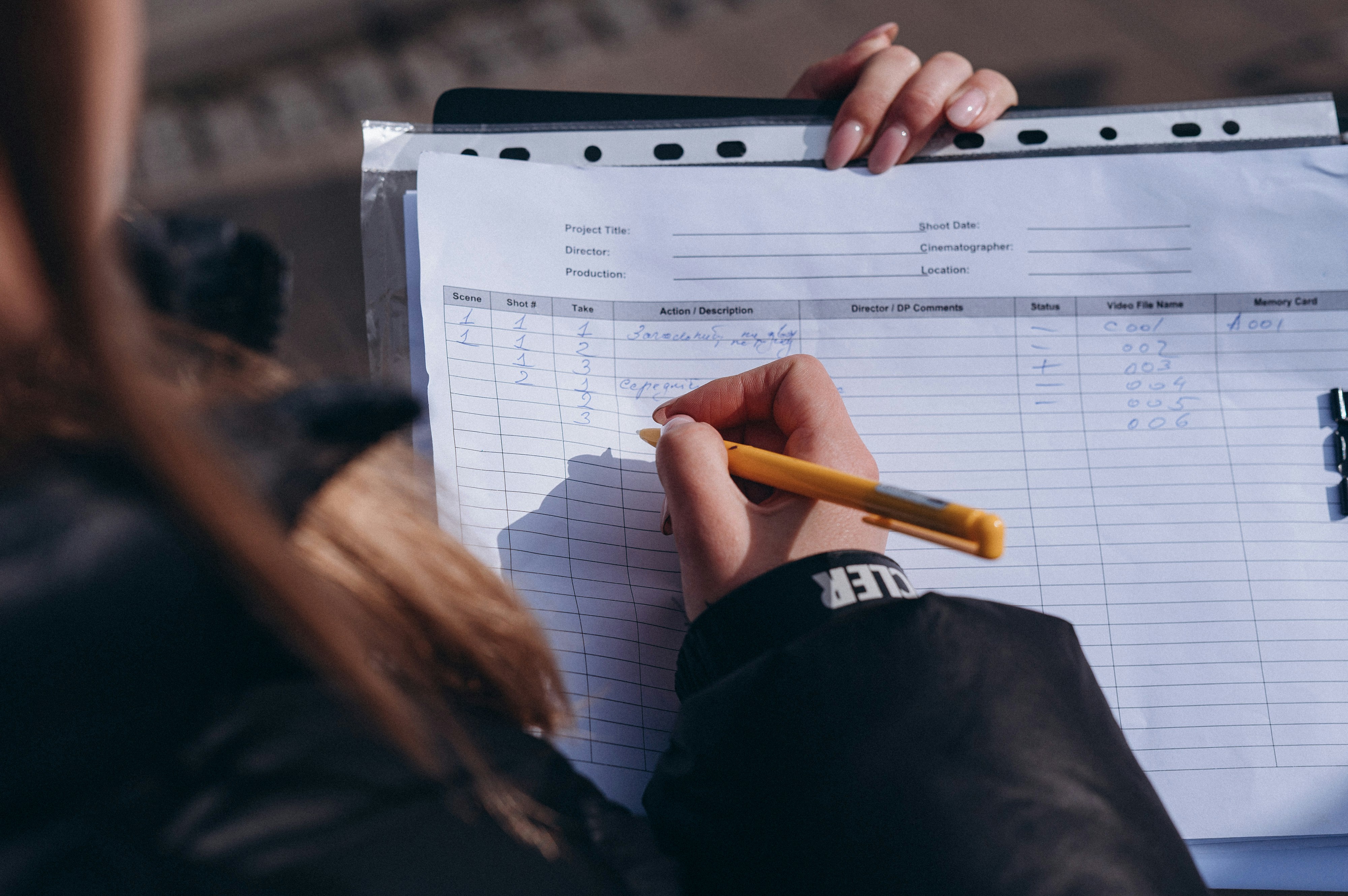 Hand Hovering Over a Form: Capturing a Moment of Data Entry