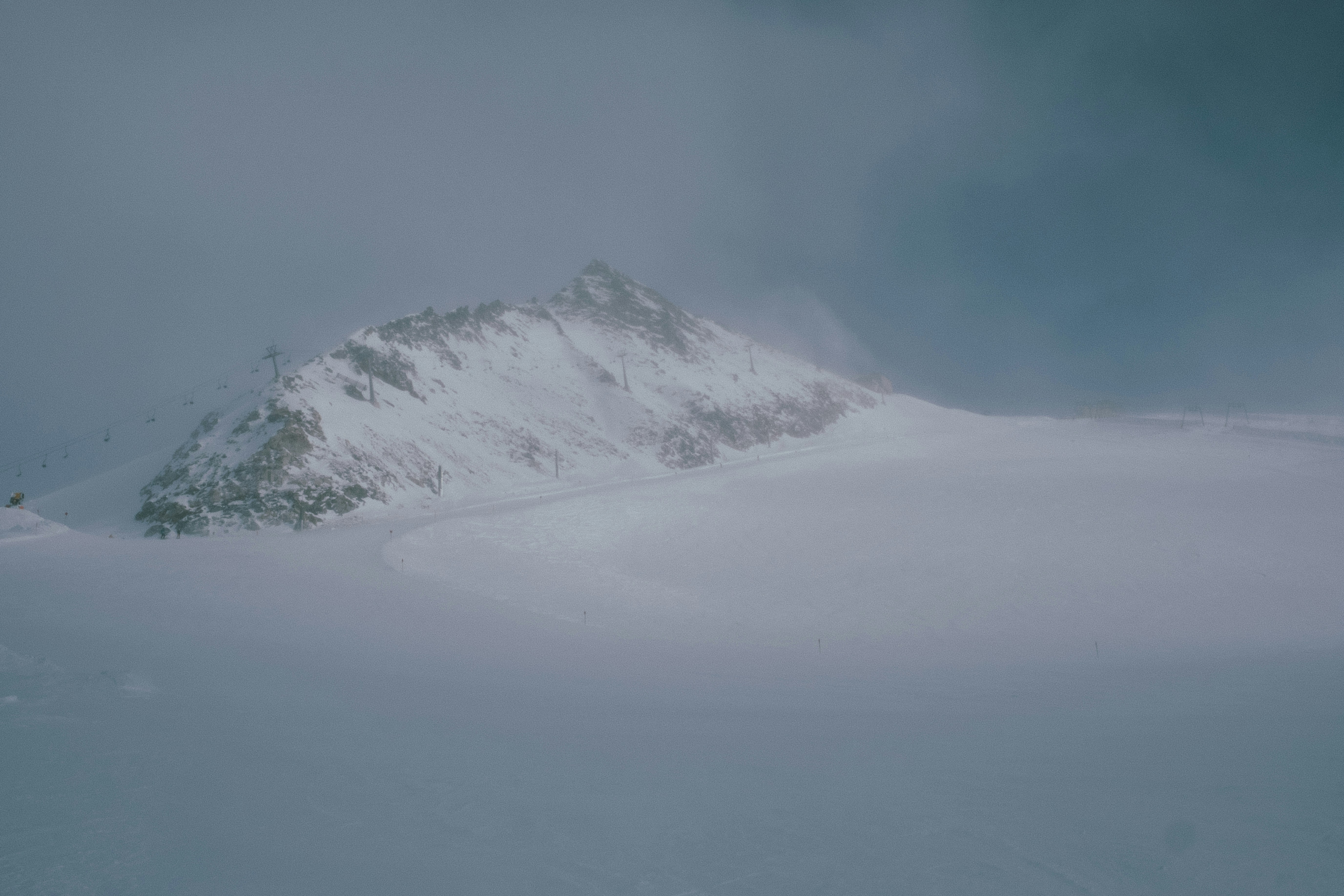 Snowbound Summit: A Quiet Ridge Emerging from Mist