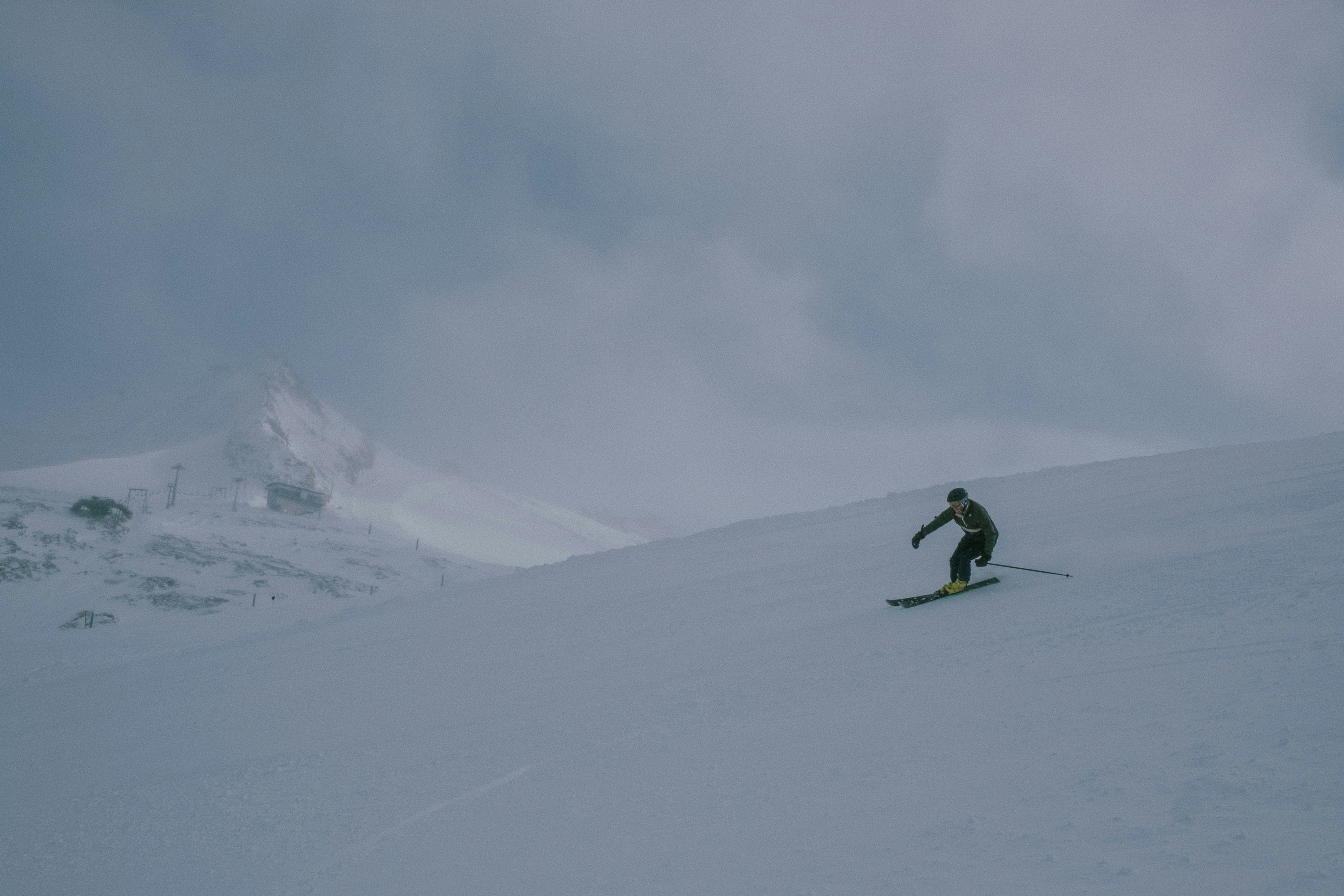 Skier Carving Through Quiet Avalanche of Snow