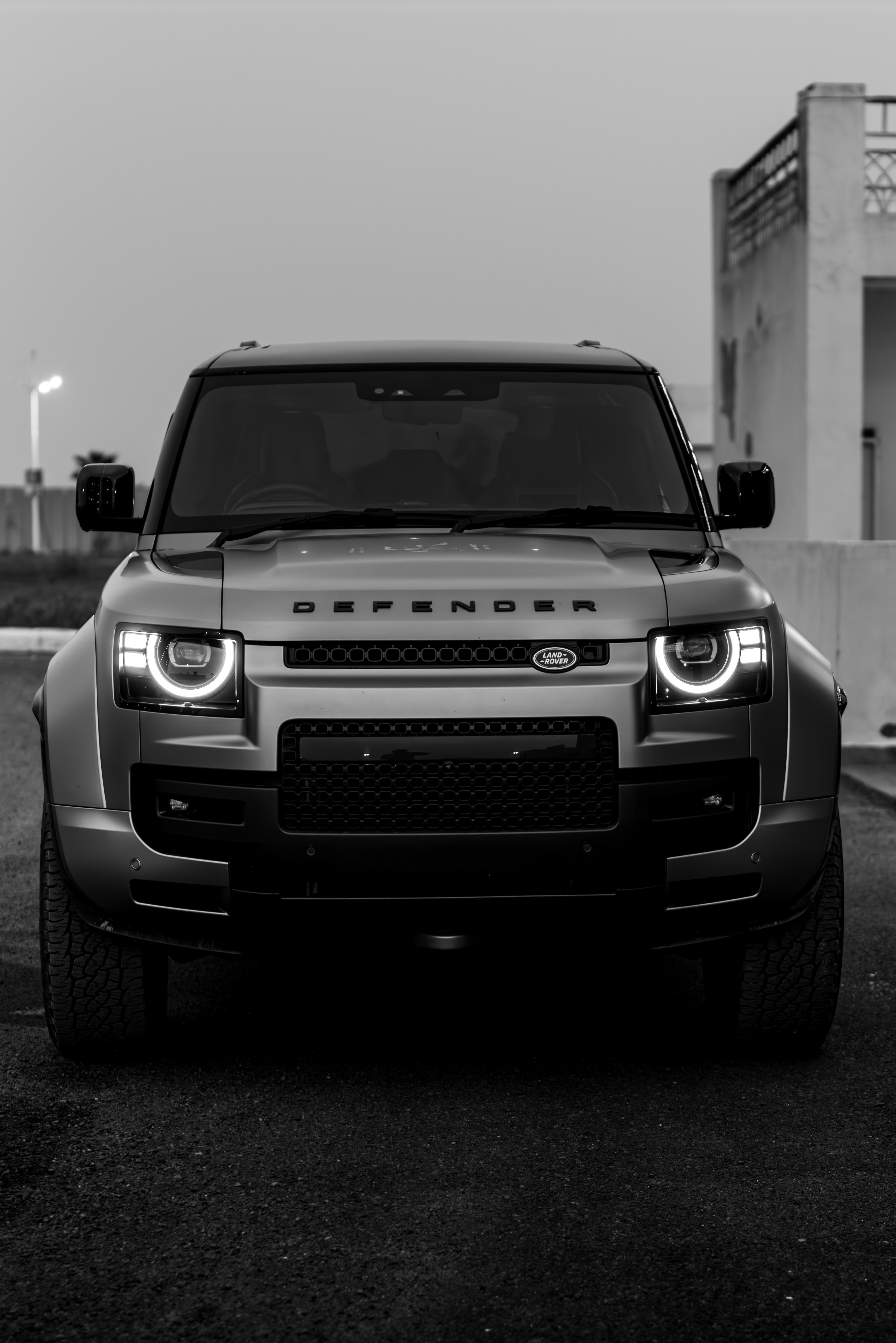 Bold Defiance: FrontView of a Land Rover Defender in Monochrome