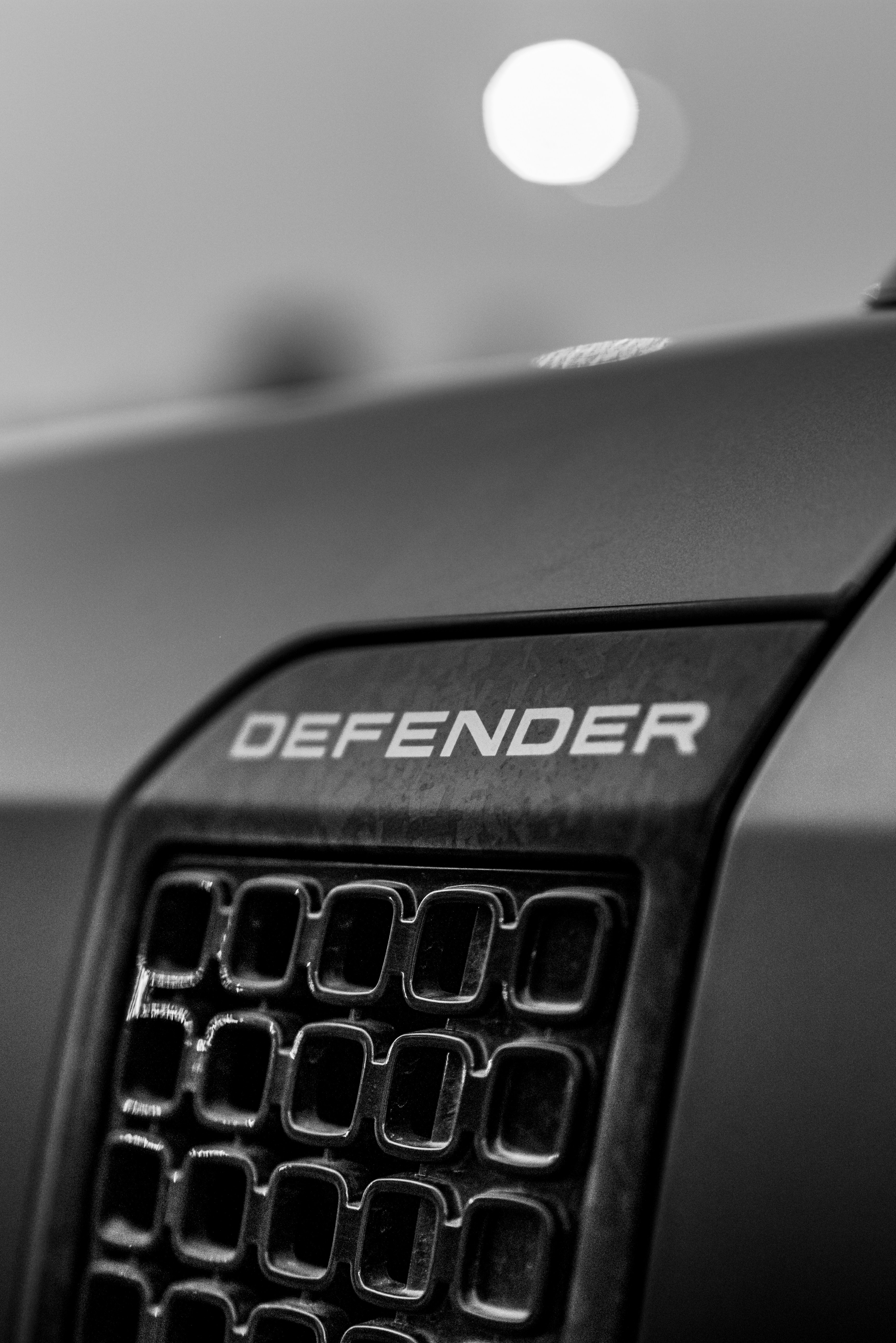 Defender Badge and Grille: A Close-Up of rugged automotive Detail