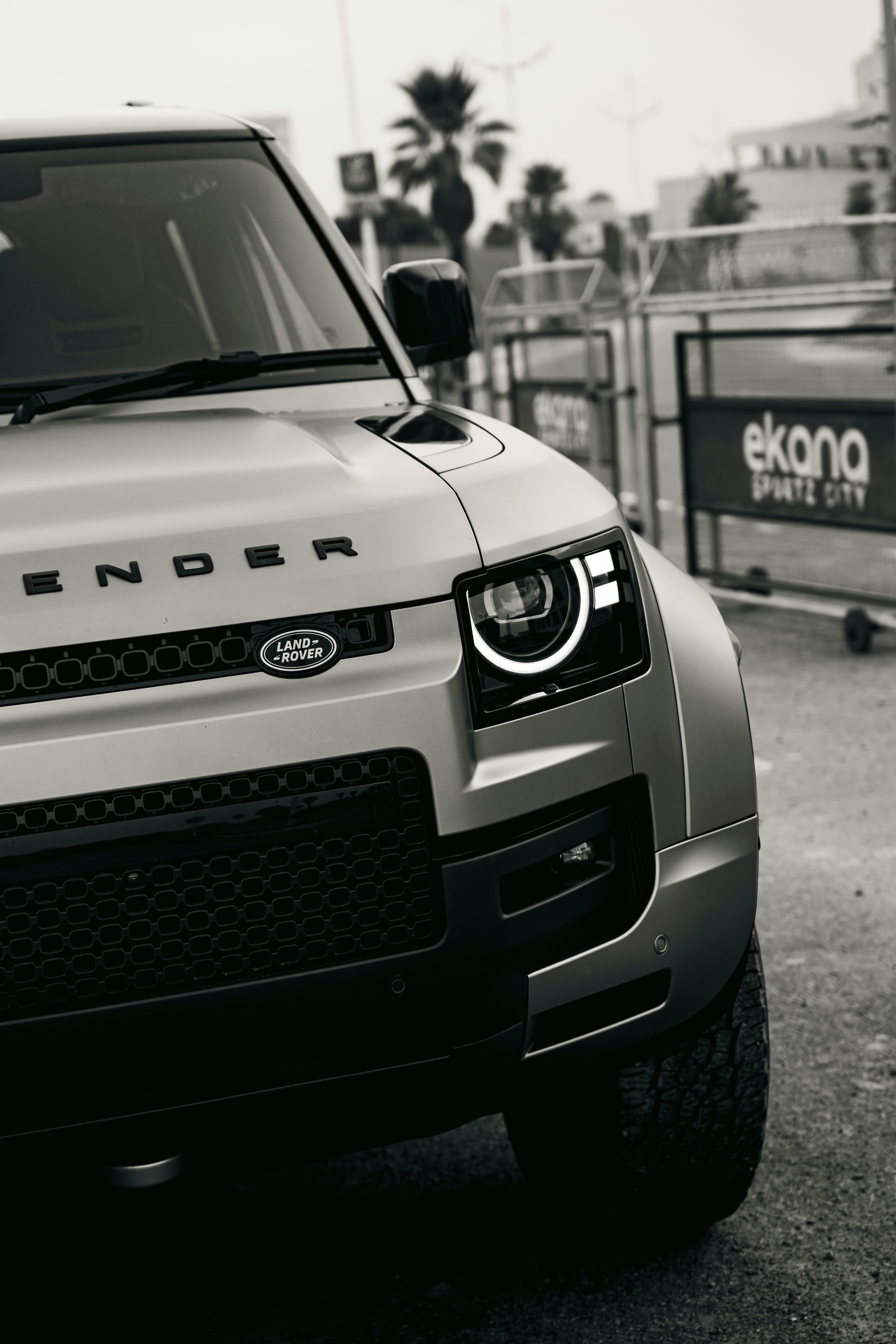 Front-Quarter Glance: A Sunset-Quiet Land Rover Emerges from the Frame