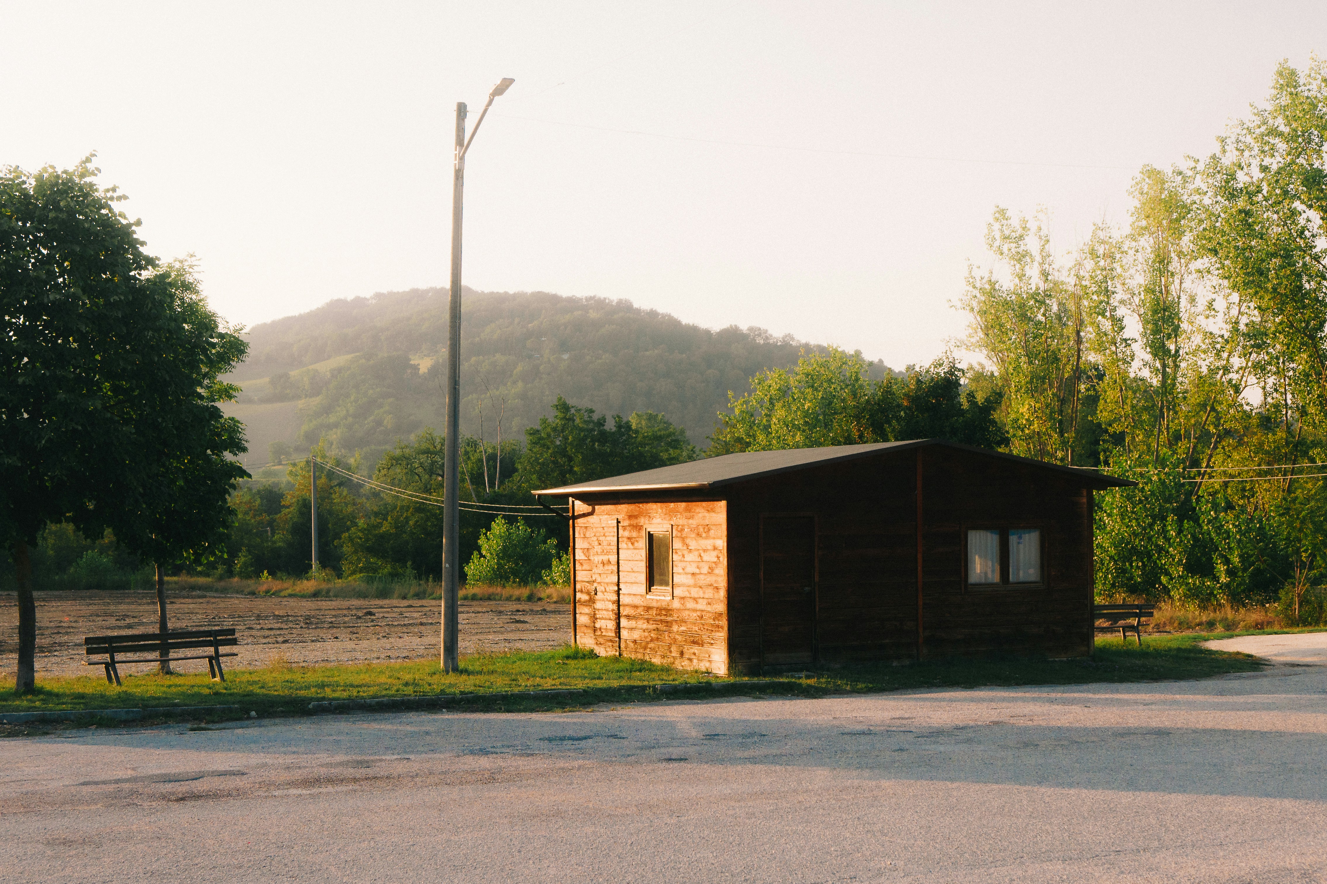Wooden Hut by the Hillside at Sunset