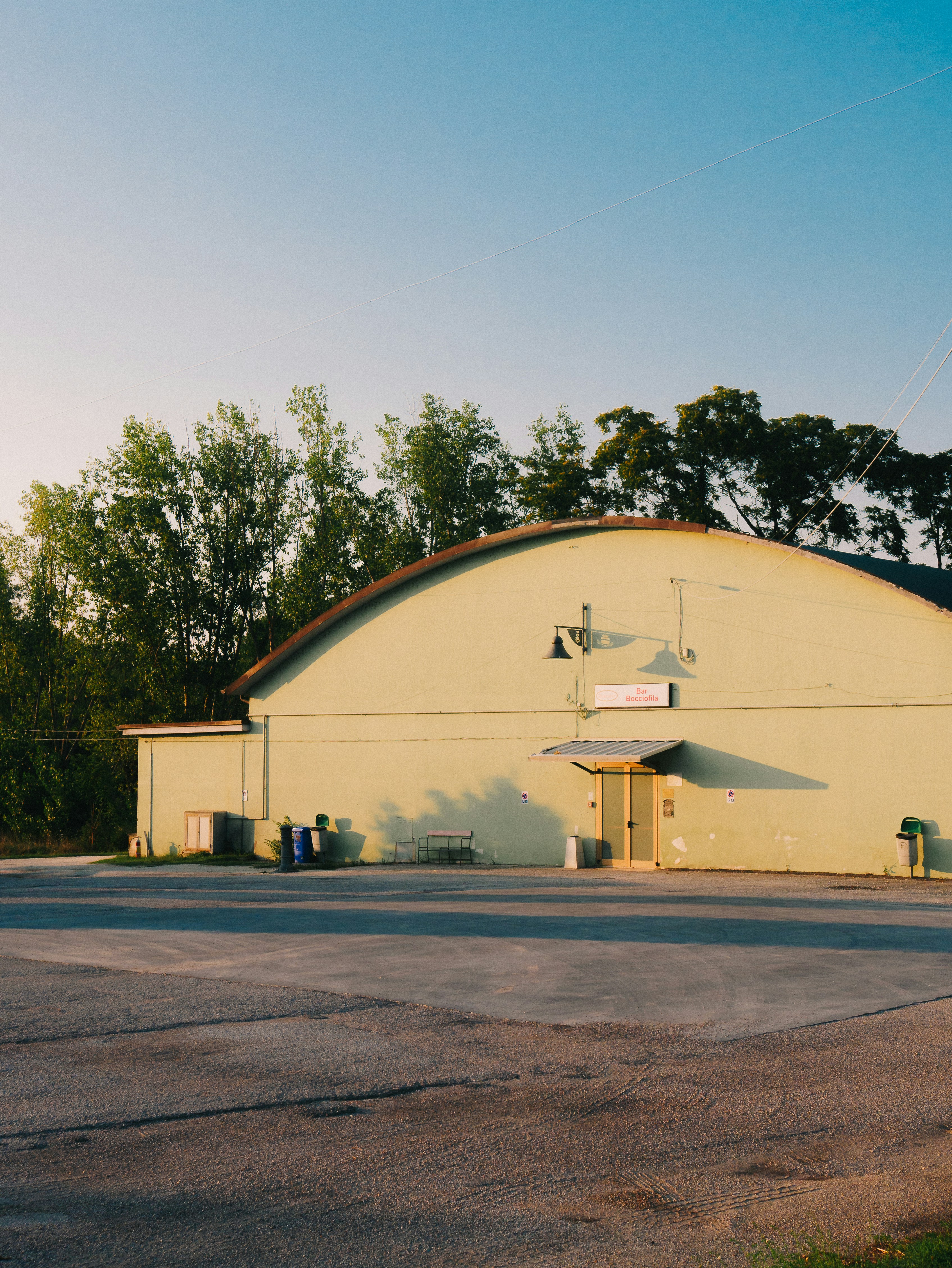 Sunlit Quonset Roof: Quiet Warehouse Under Open Sky
