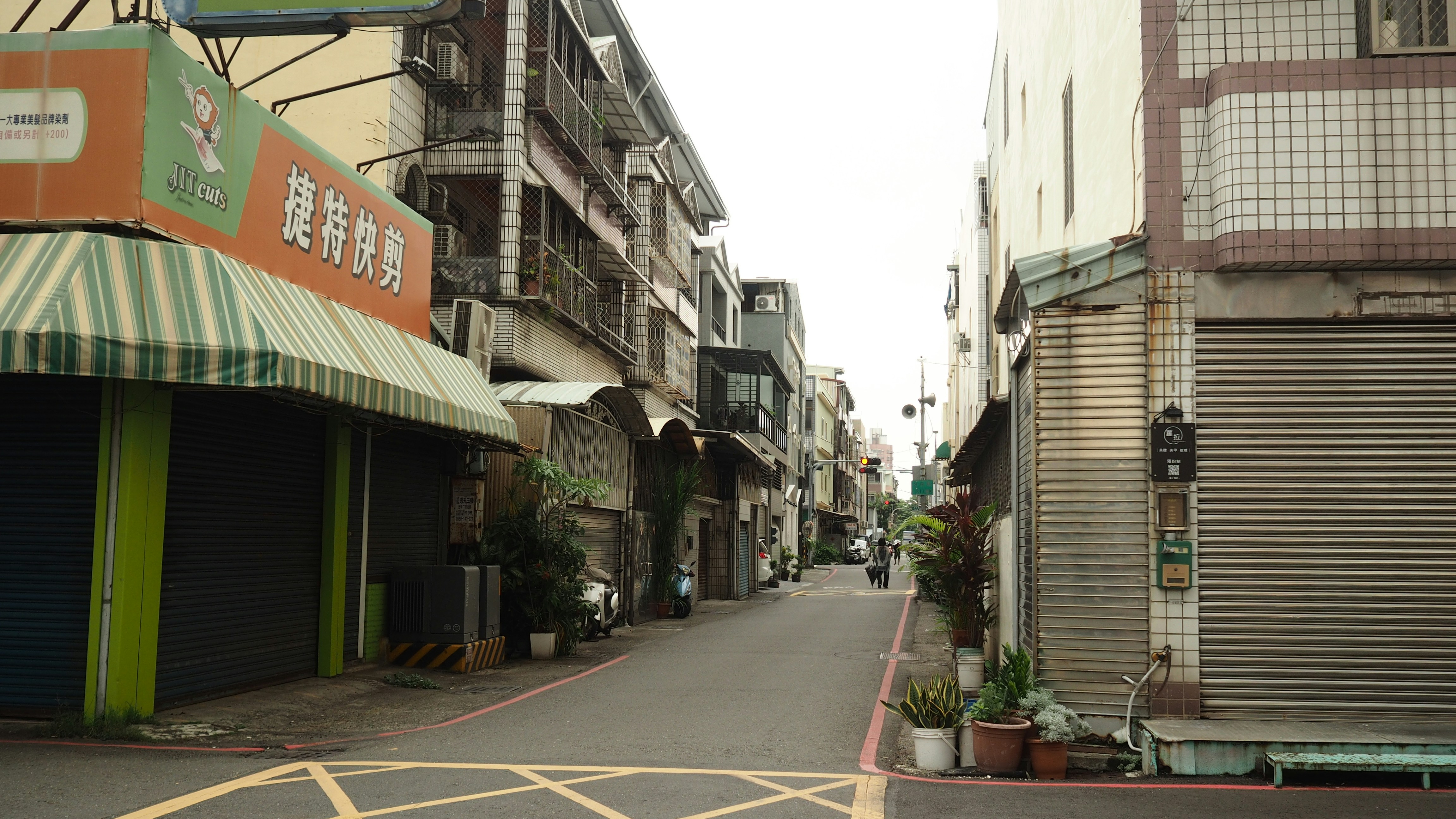 Quiet Alleyway Commerce Under Shuttered Facades