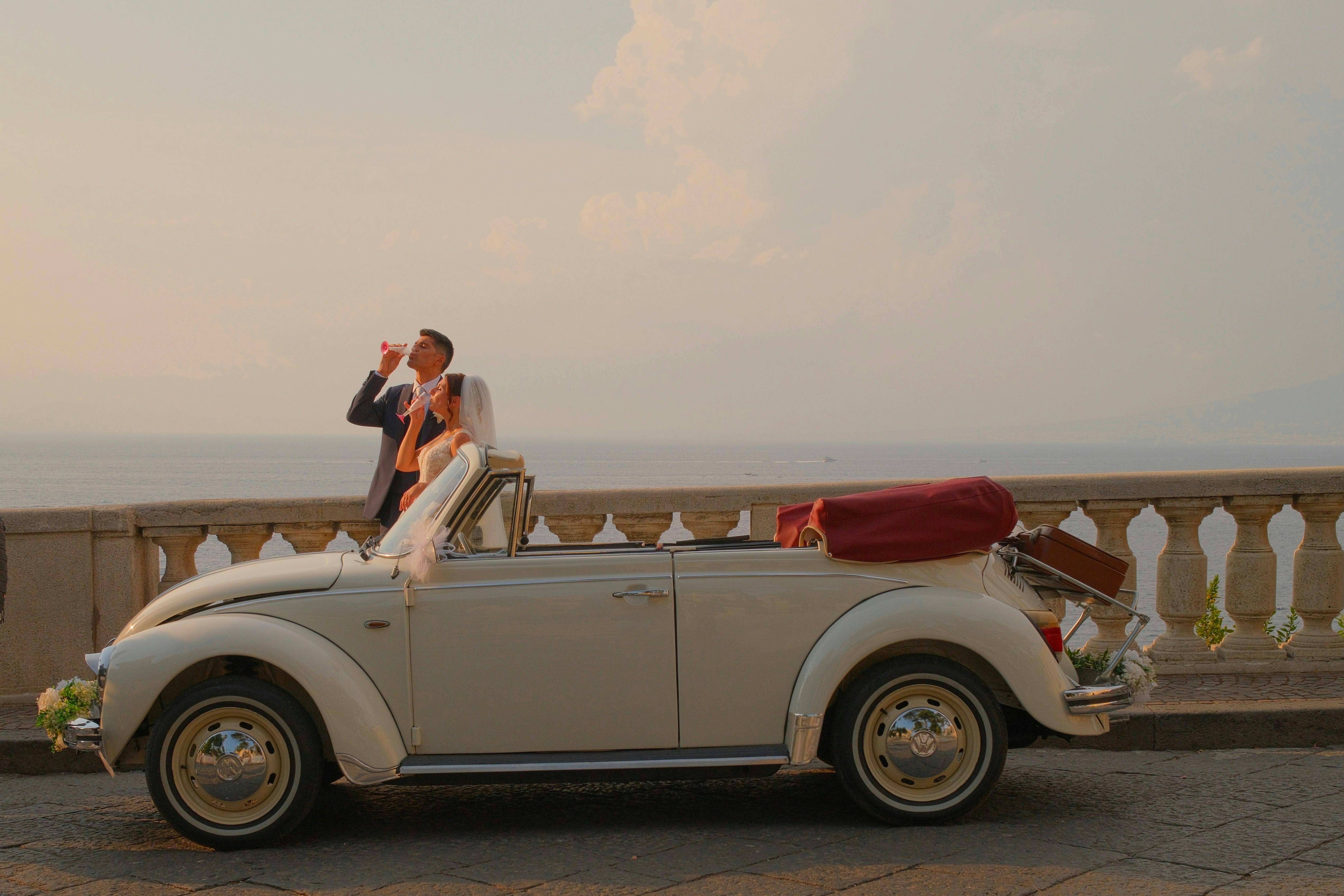 Sunset Drive: A Couple Commuting Time in a Cream Convertible
