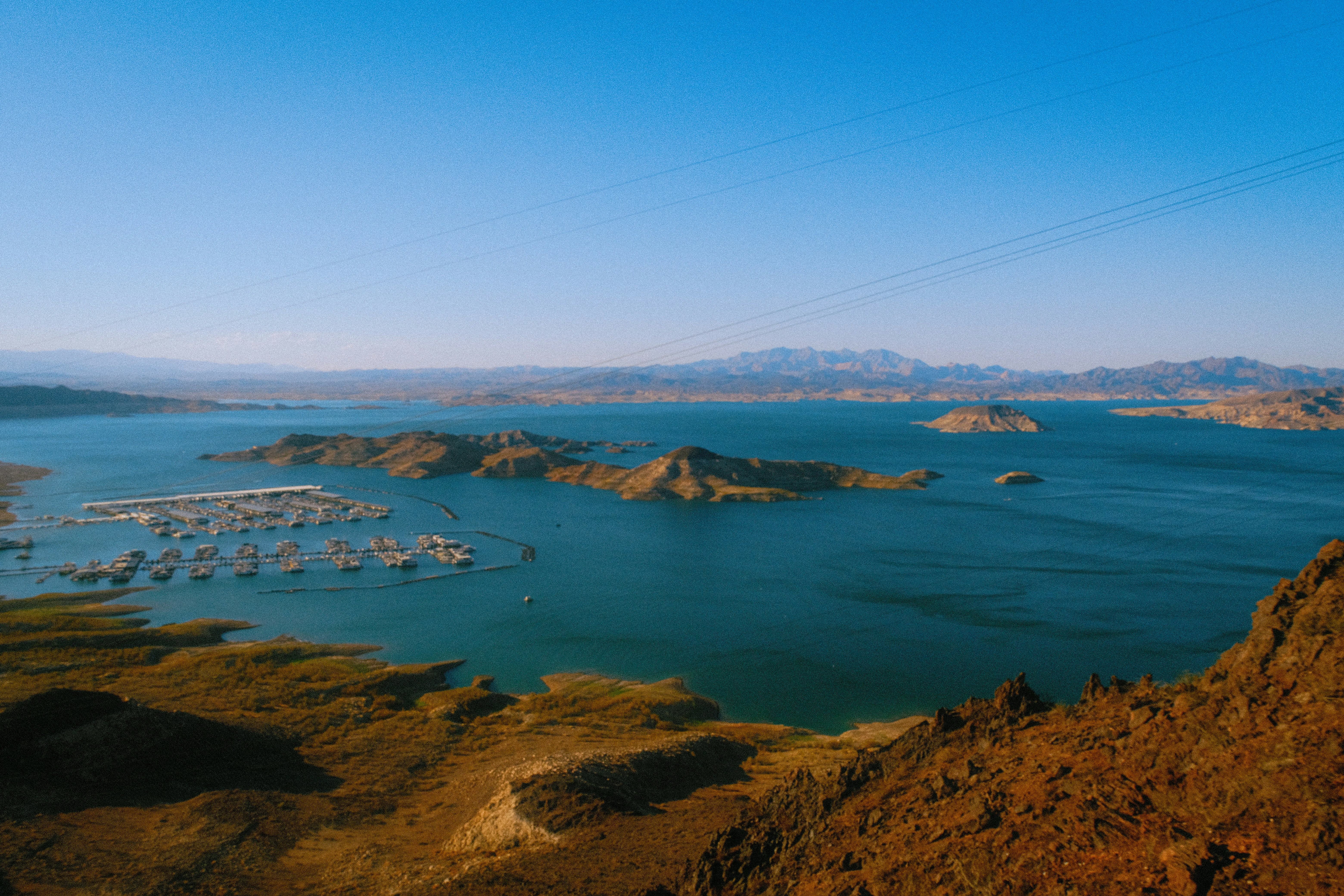 Sunlit Ridge Overlooking a Serene Bay with Isolated Islands