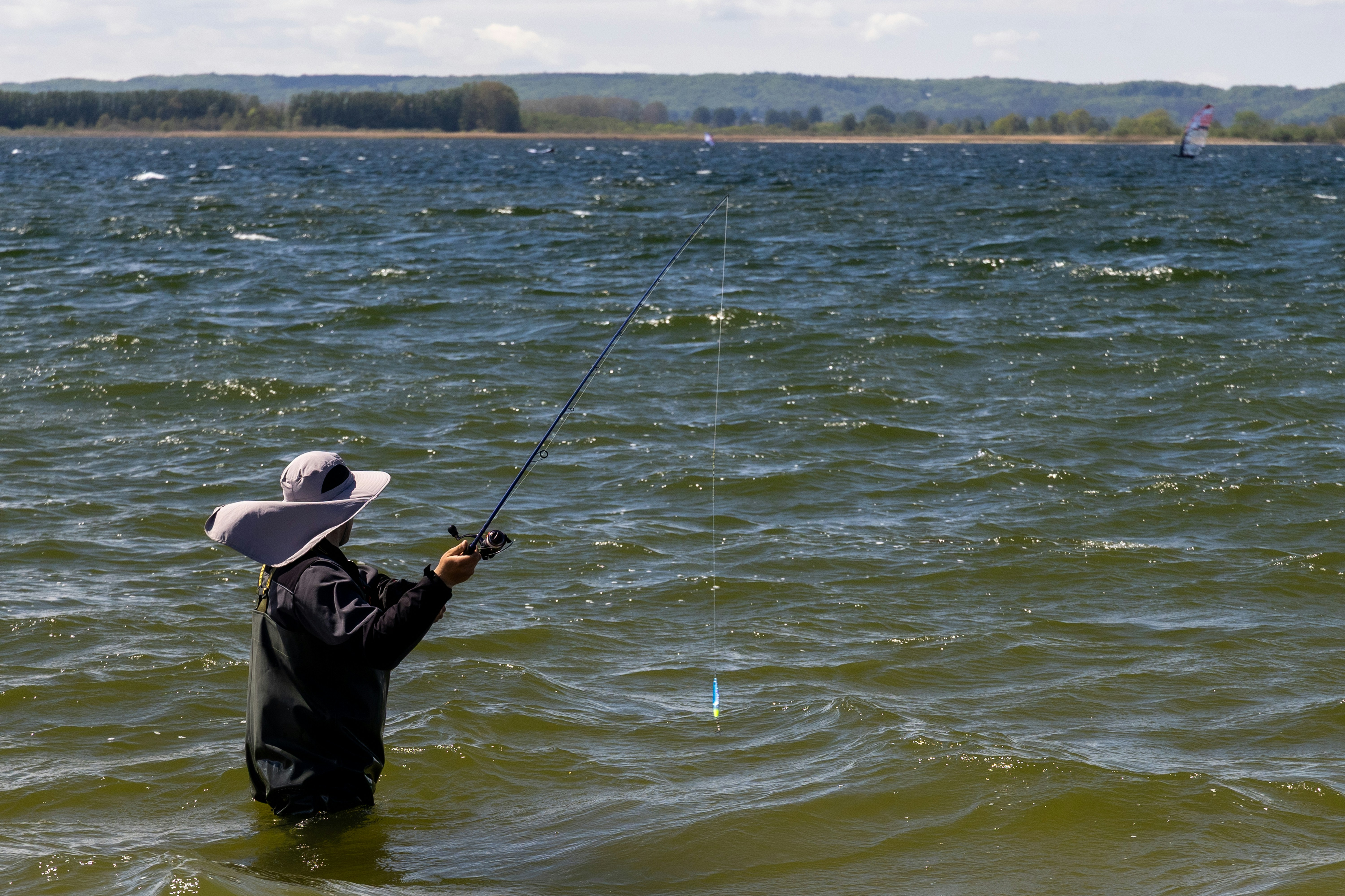 Toward a Quiet Bend: Angler Standing in Wavering Light