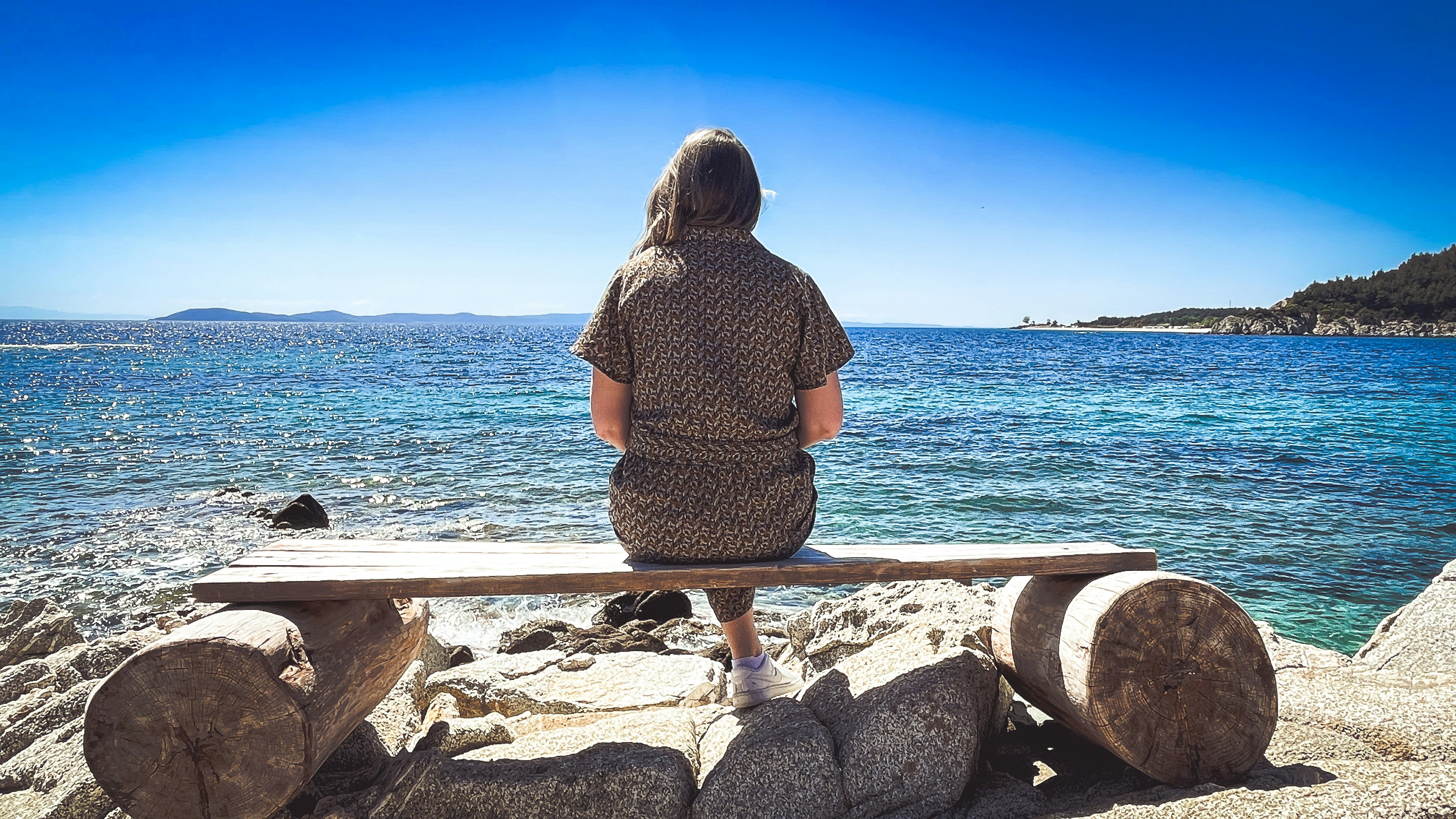 Solitary Seaside Moment: Traveler on the Bench