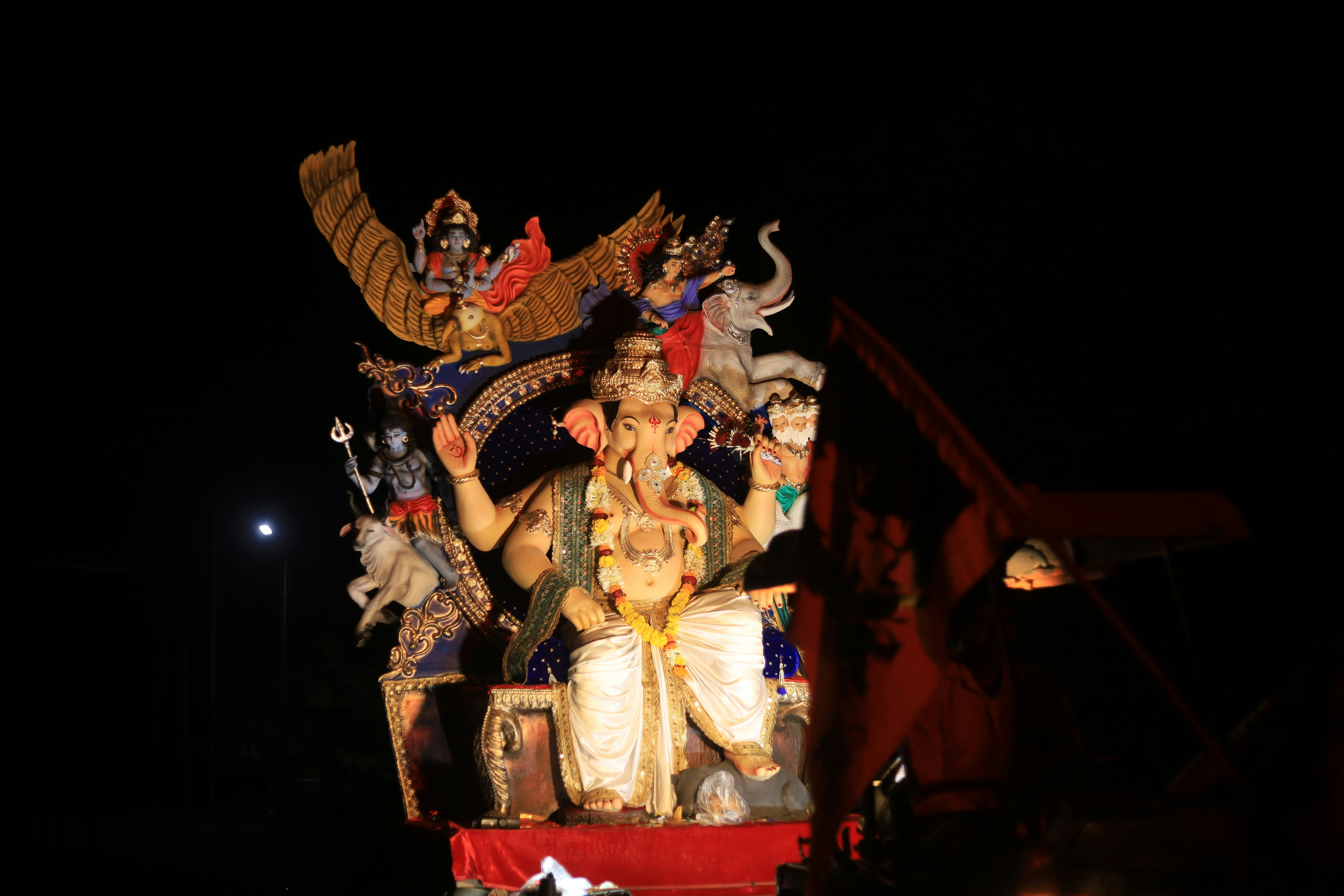 Night Entry: An Illuminated Tableau of Mythic Deities on a Carved Float