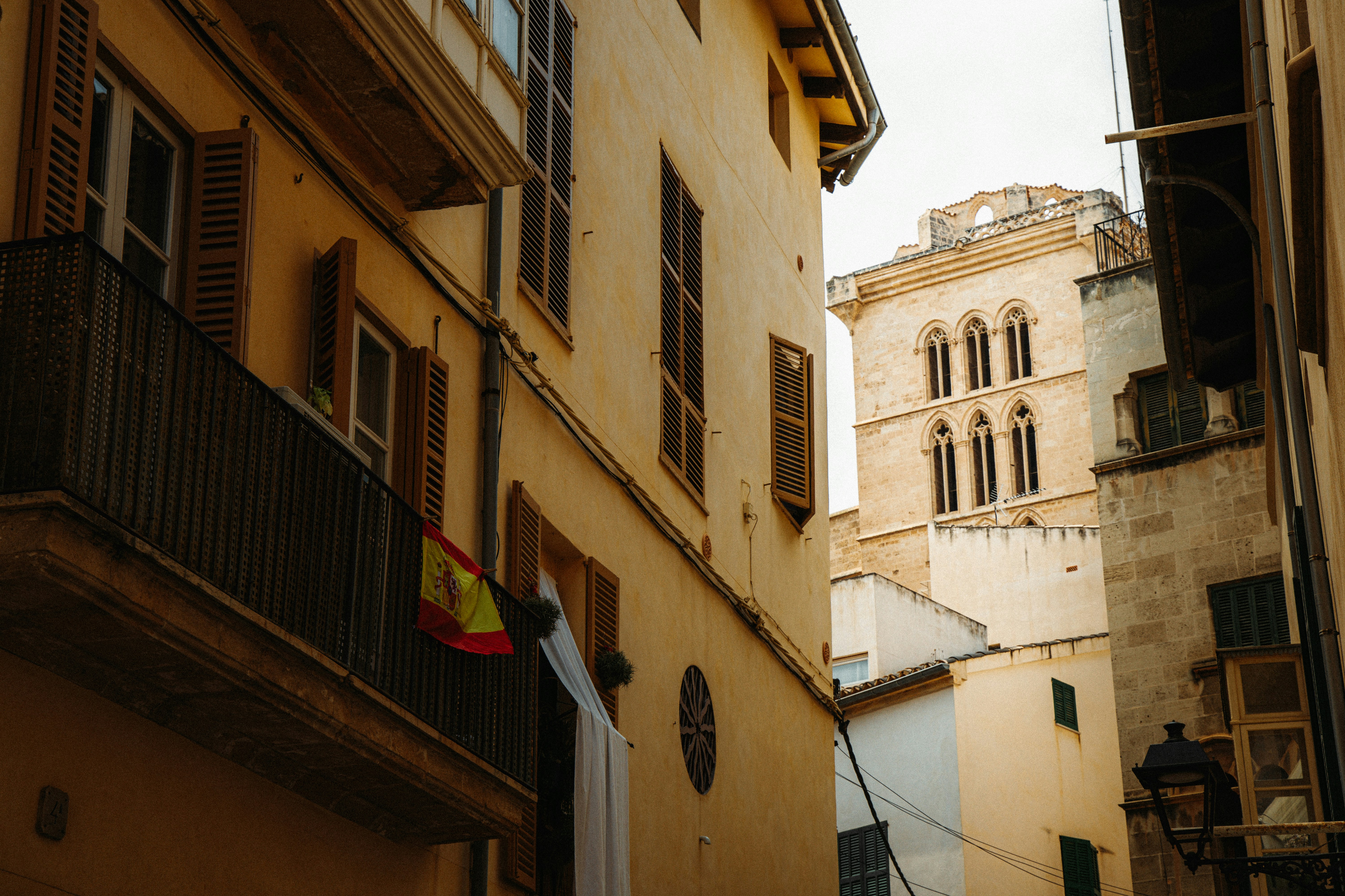 Sunlit Facades and a Bell-Tower glimpse from a Narrow Lane