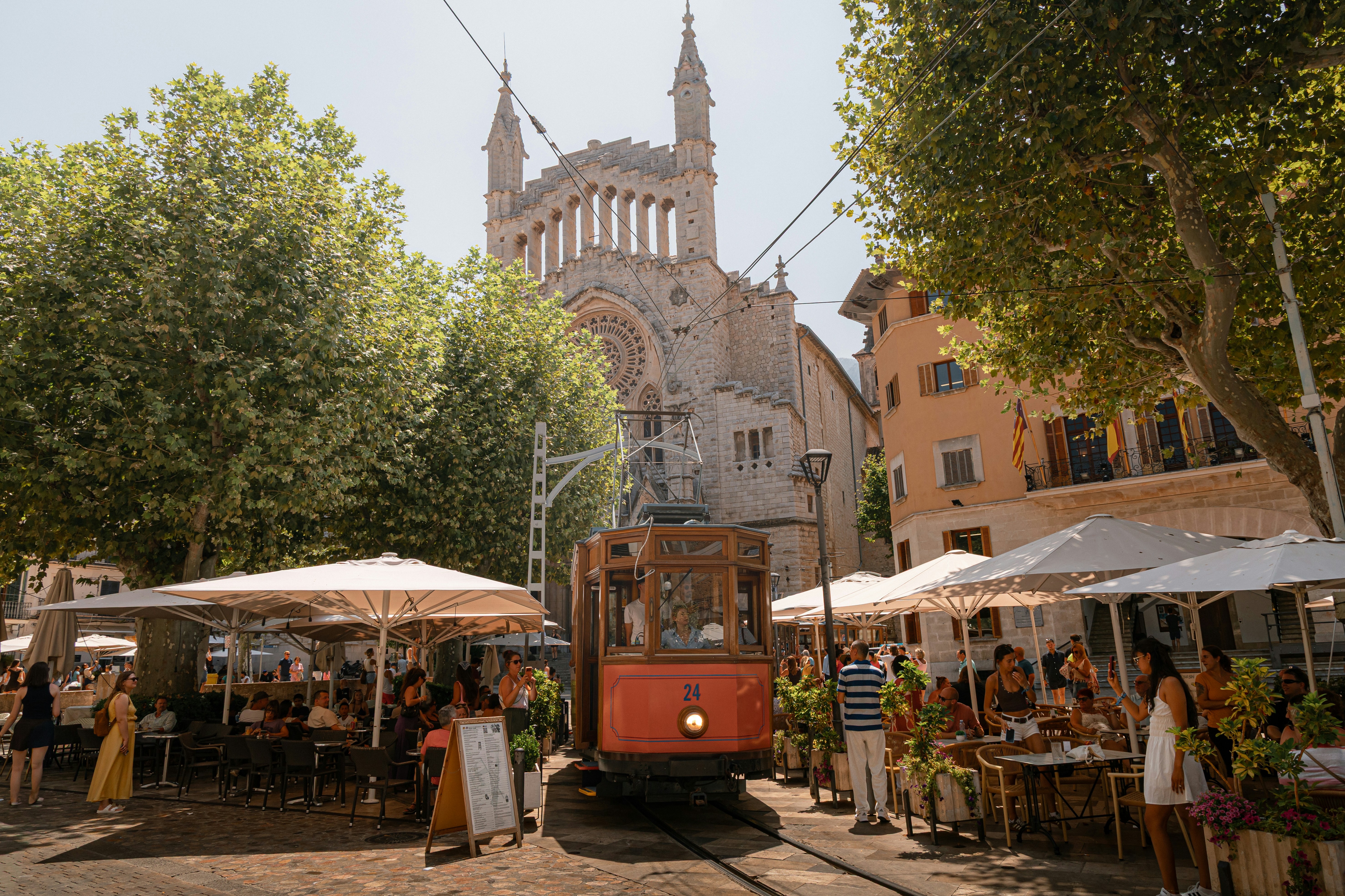 A Sunlit Tram in a Historic Square