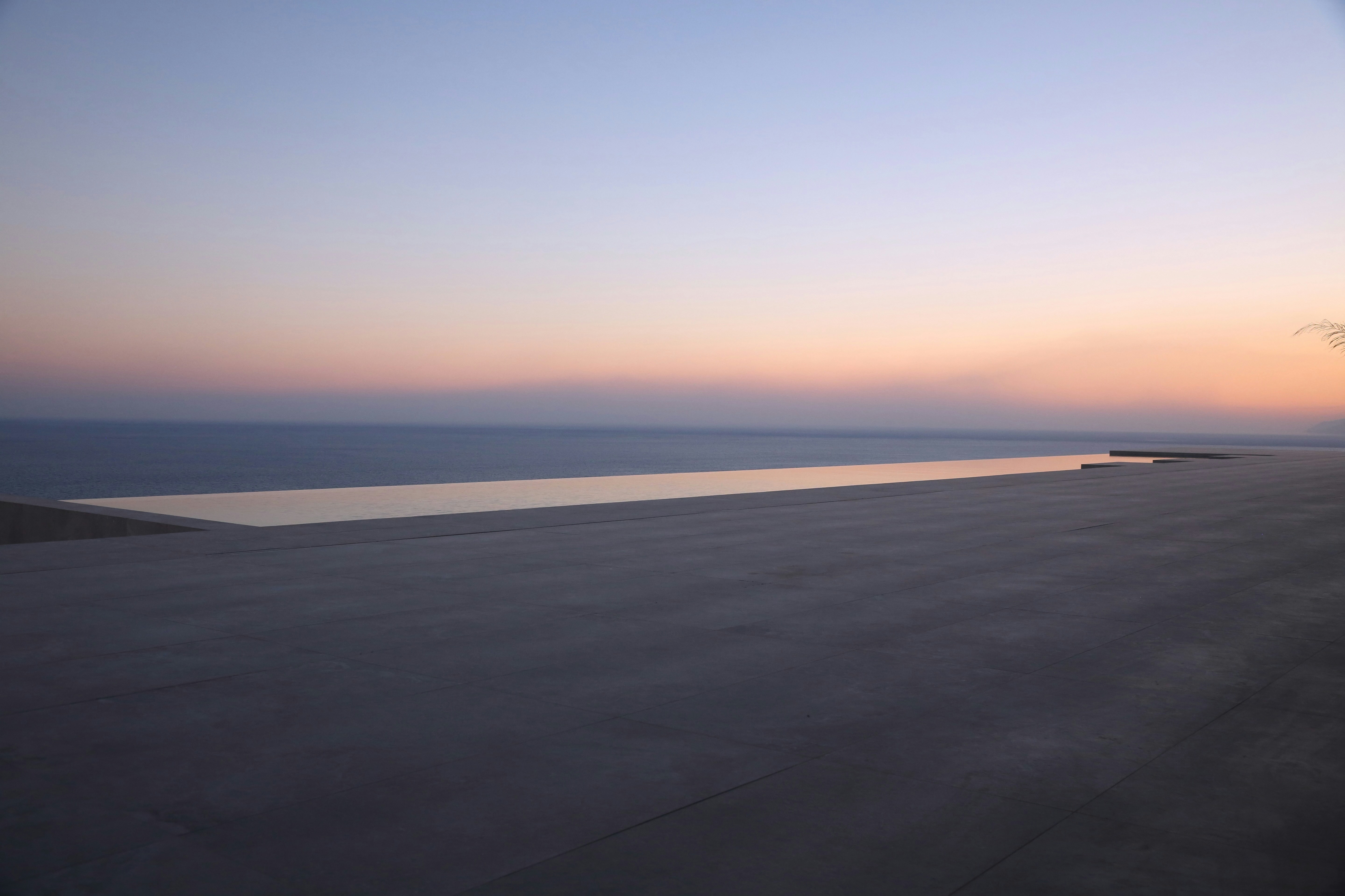 Horizon Edge: Quiet Rooftop Overlooking the Sea at Dusk