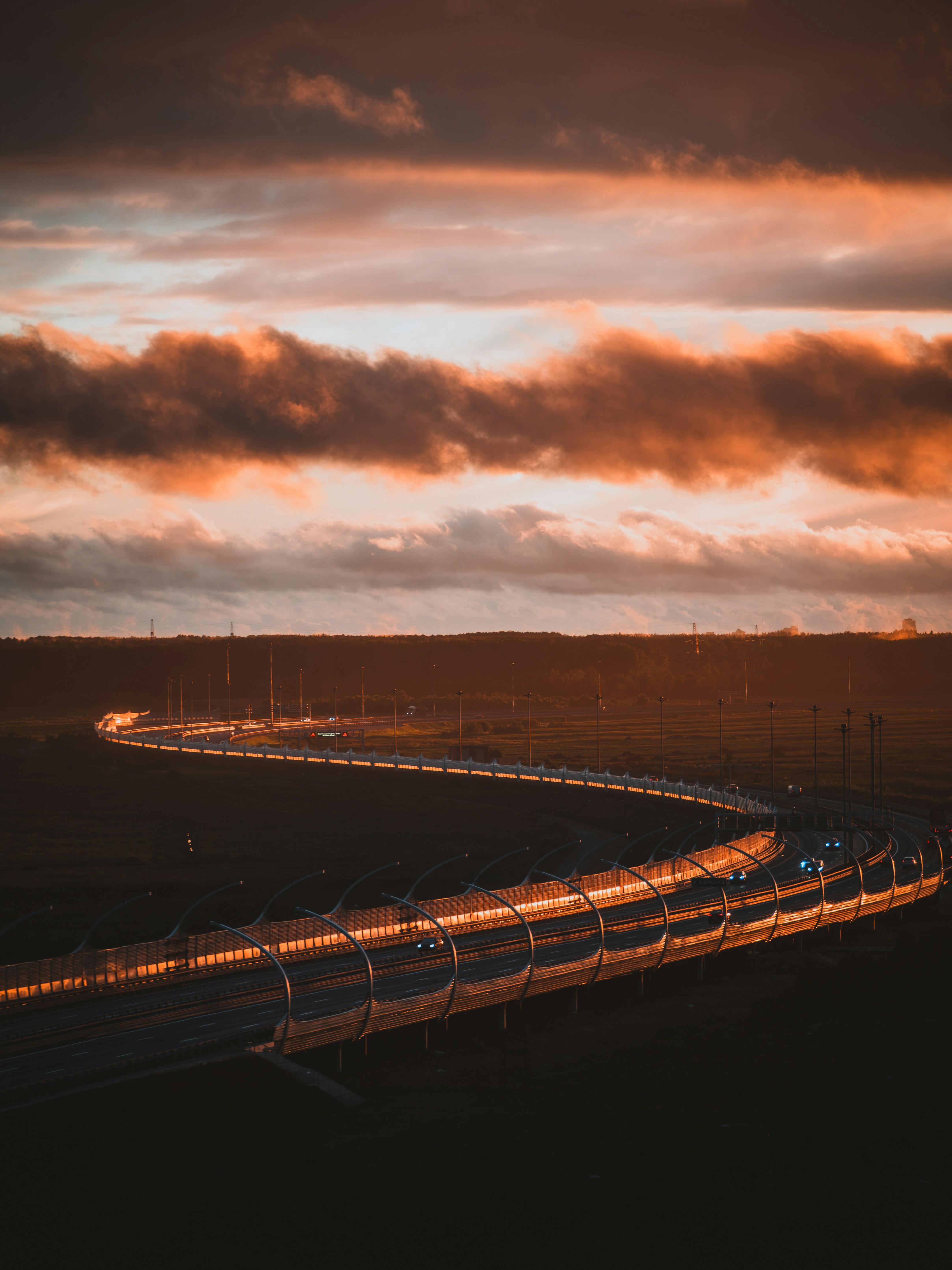 Curved Highway at Sunset: A Glowing Ribbon Through Dusk