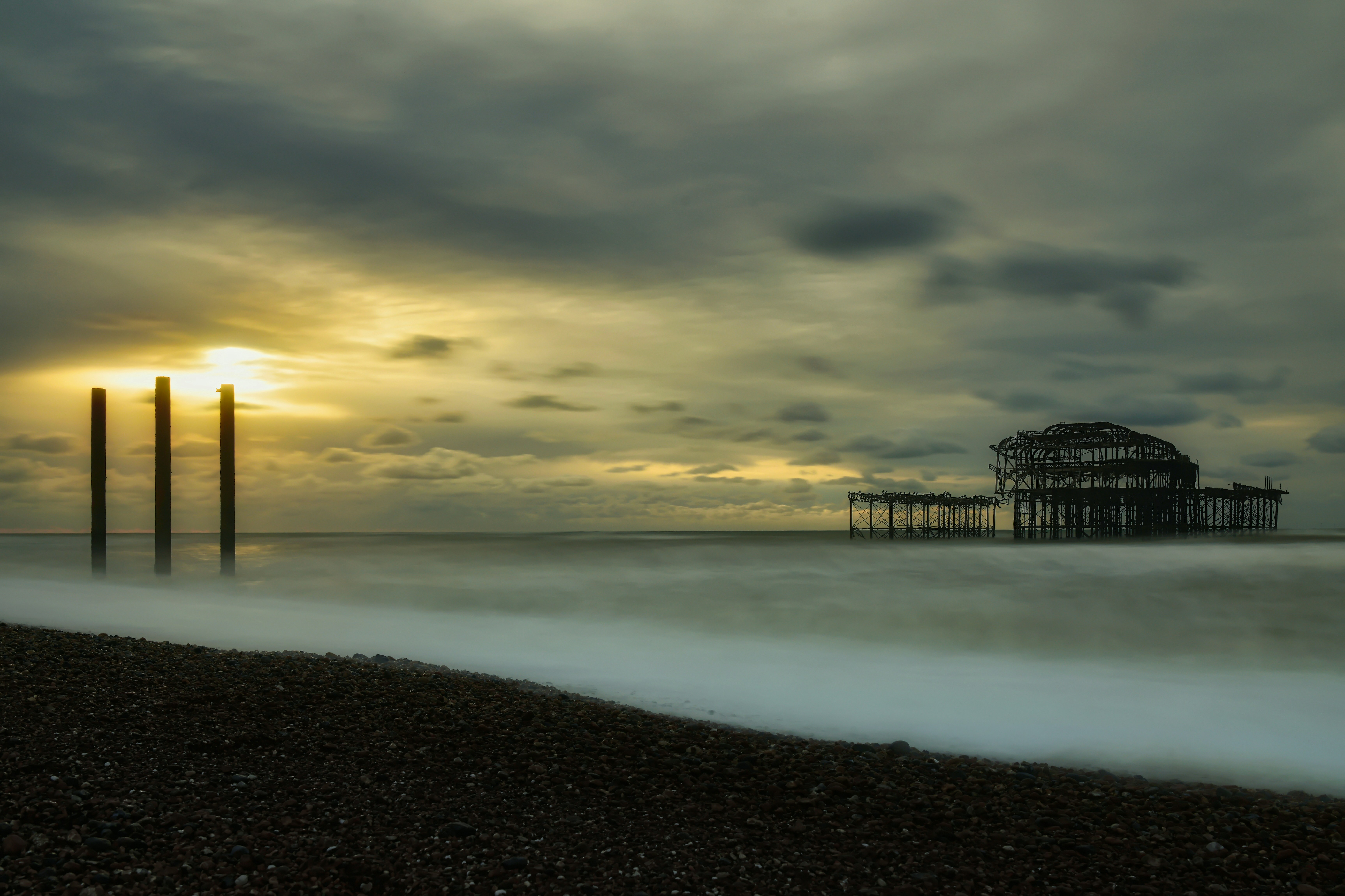 Sunlit Sentinel: Pier Remains at Dawn