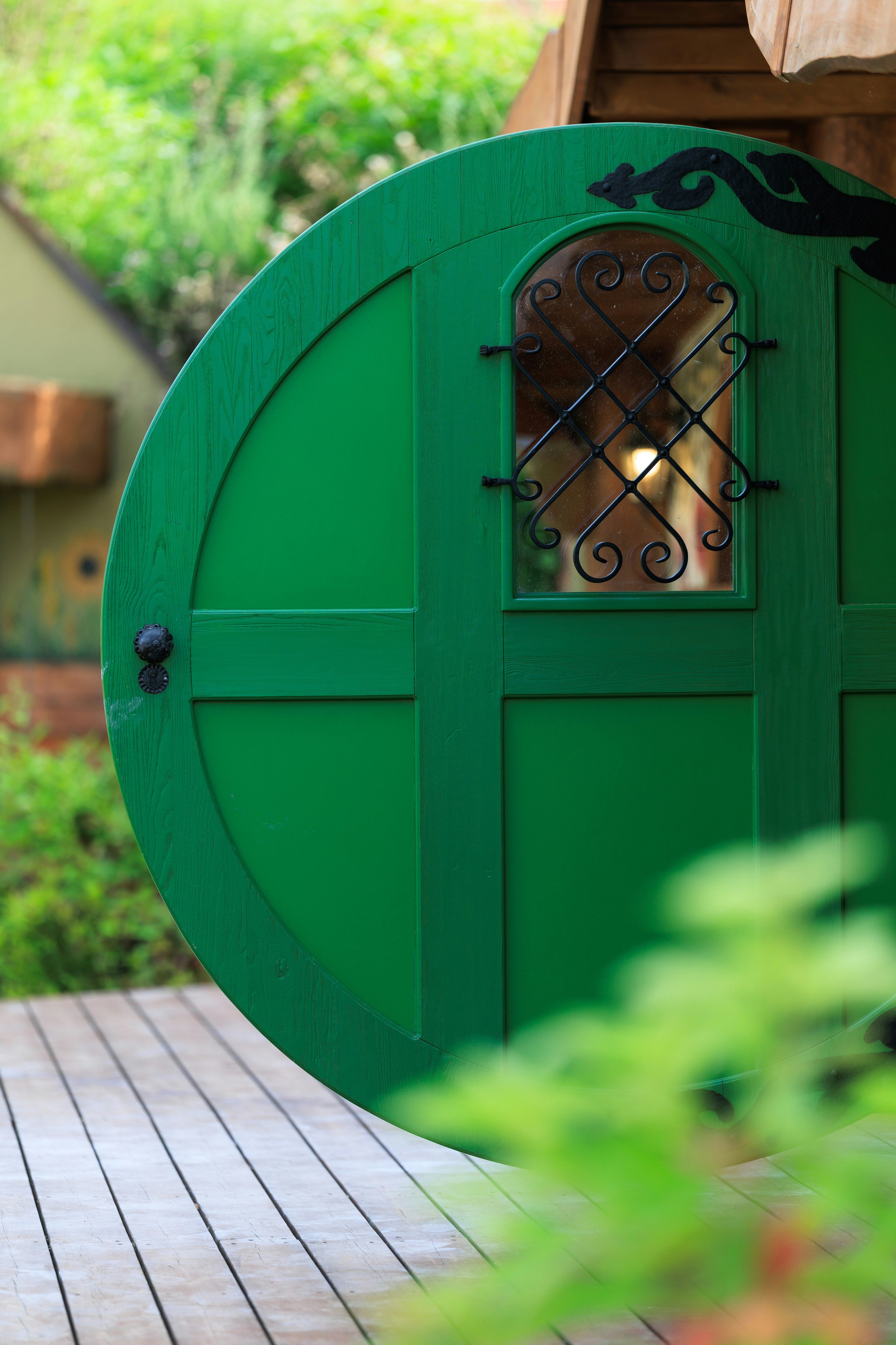 Green Portal: A Round Door Framed by Quiet Garden Light