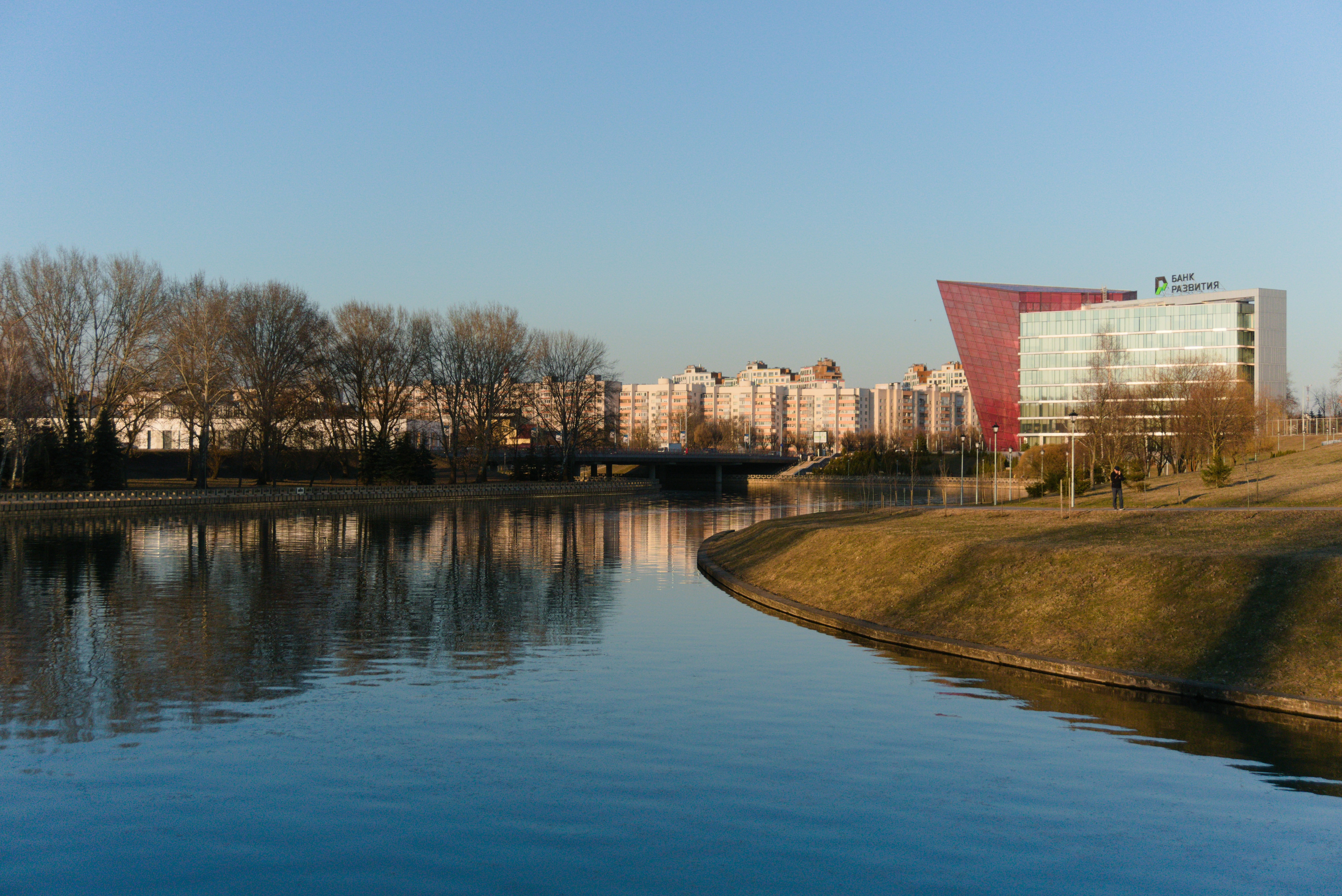 Bright Modern Building Framed by a Riverside Park