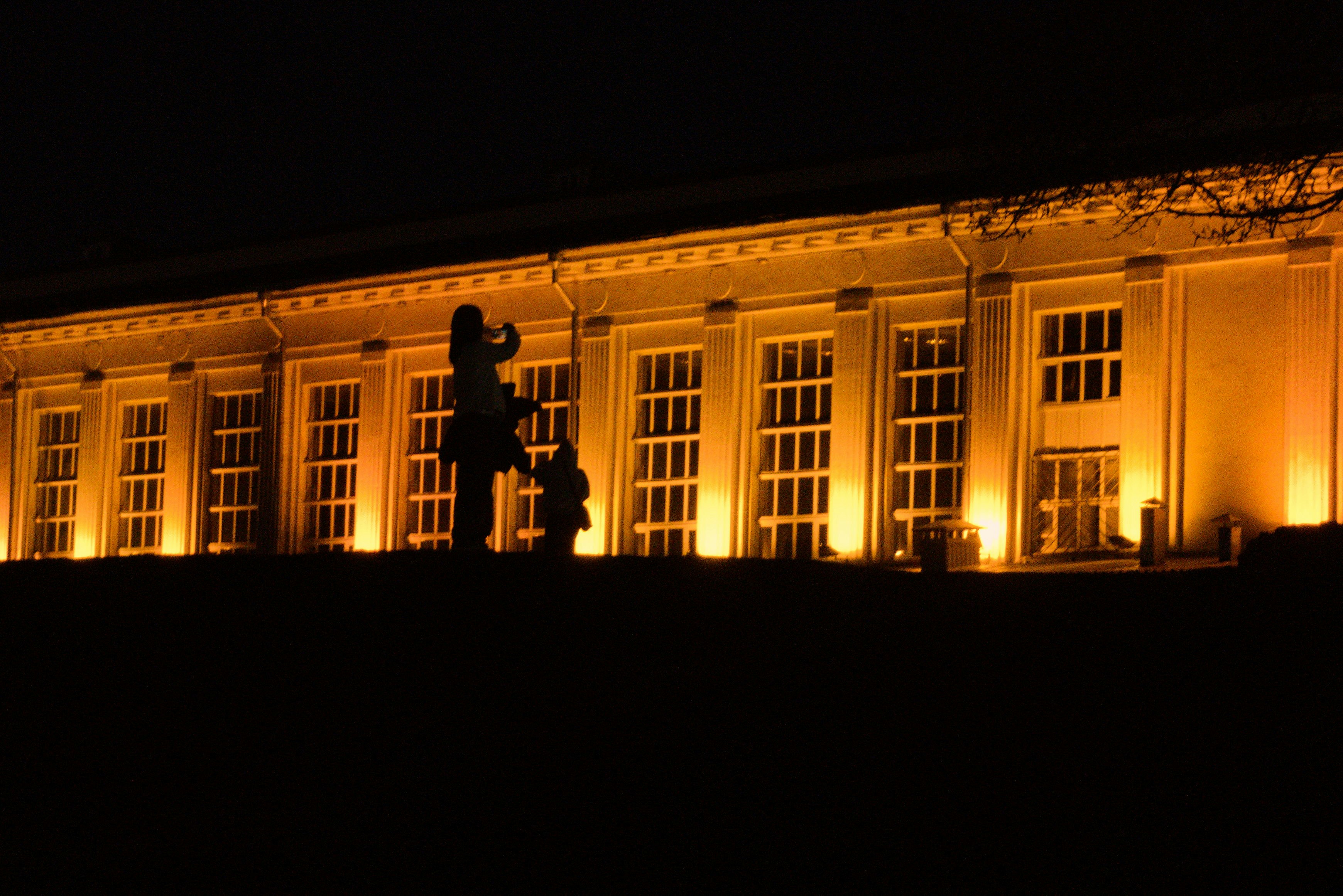 Golden Illumination: Silhouette of Couple Before the Emblematic Facade