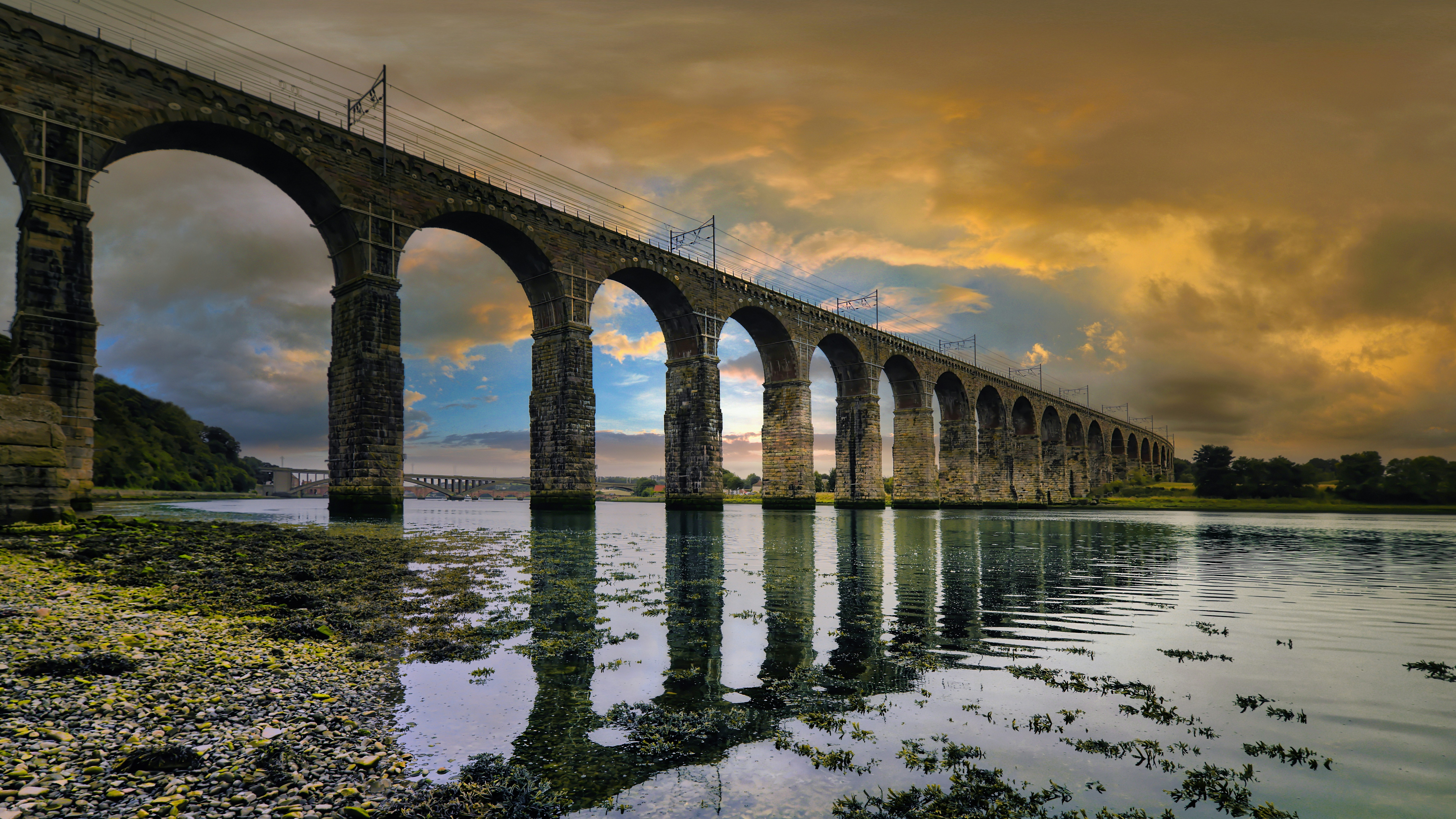 Across the Tidal Veil: A Stone Arc Stretching Toward the Sunset