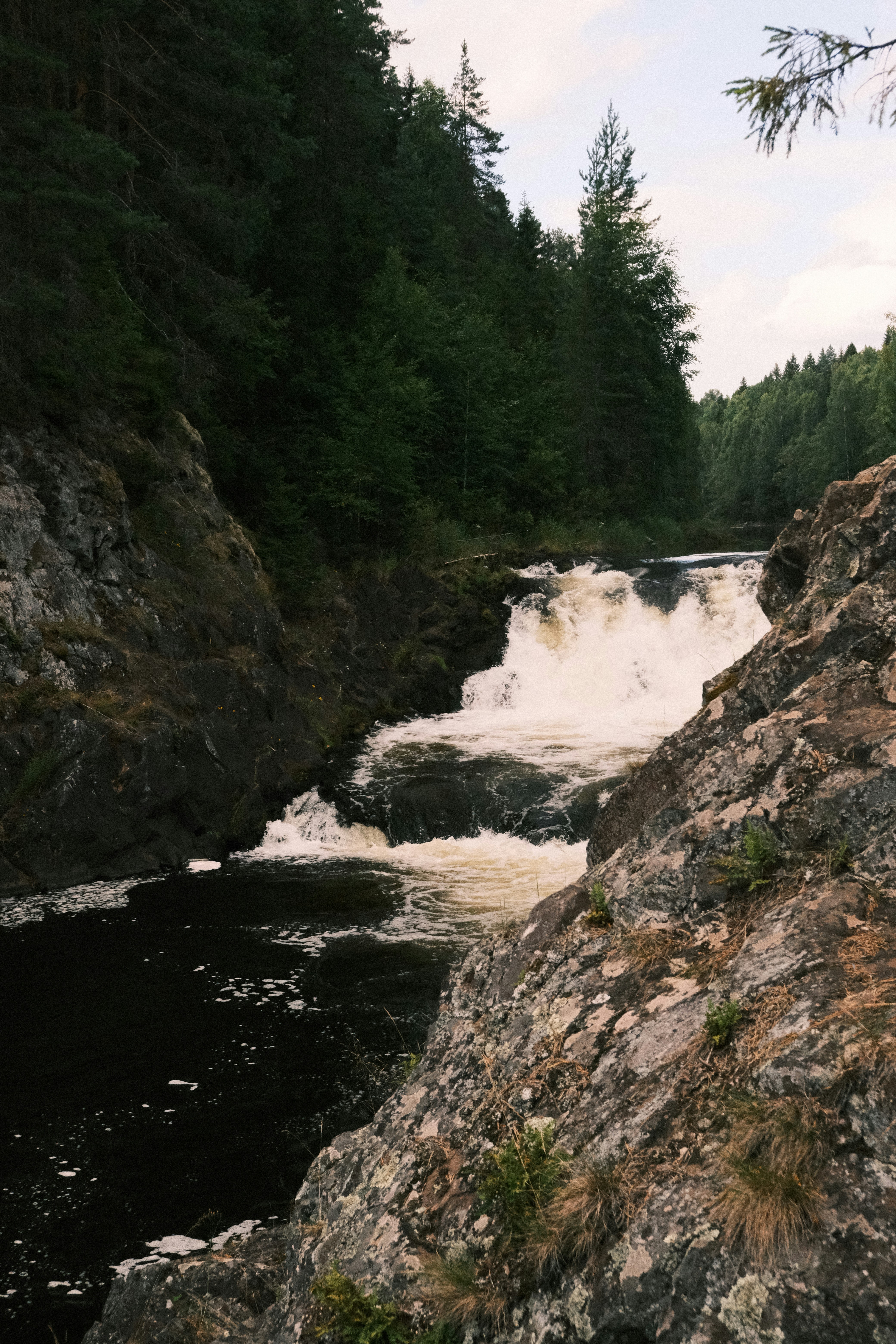 River Cascade Between Mossy Cliffs