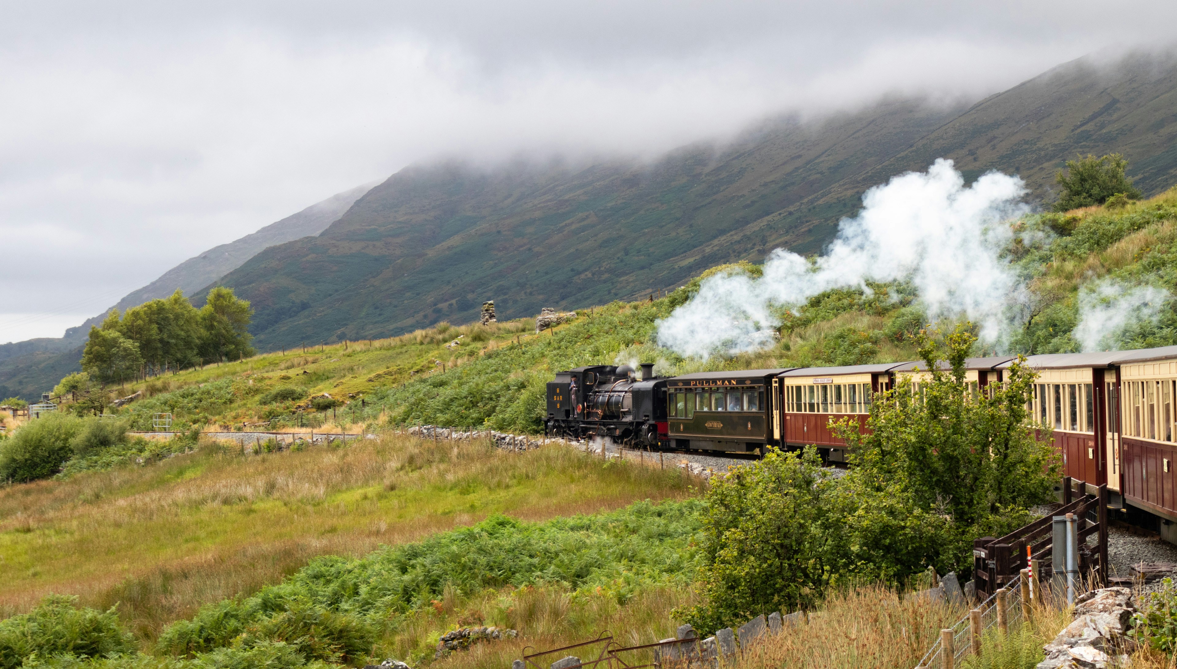 Steam on the moor: a hillside railway winds through mist