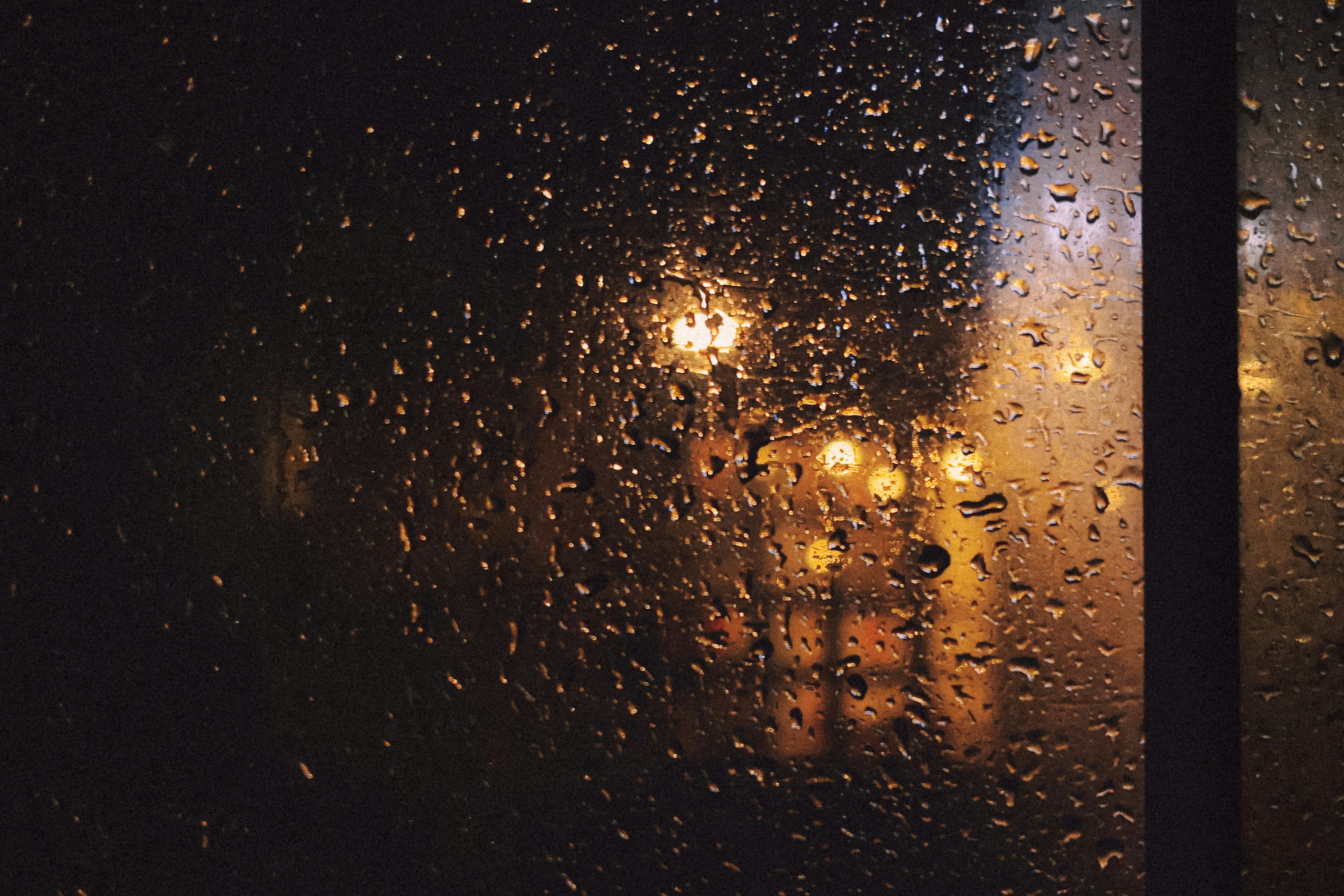 Rain-streaked Window with Neon Glows