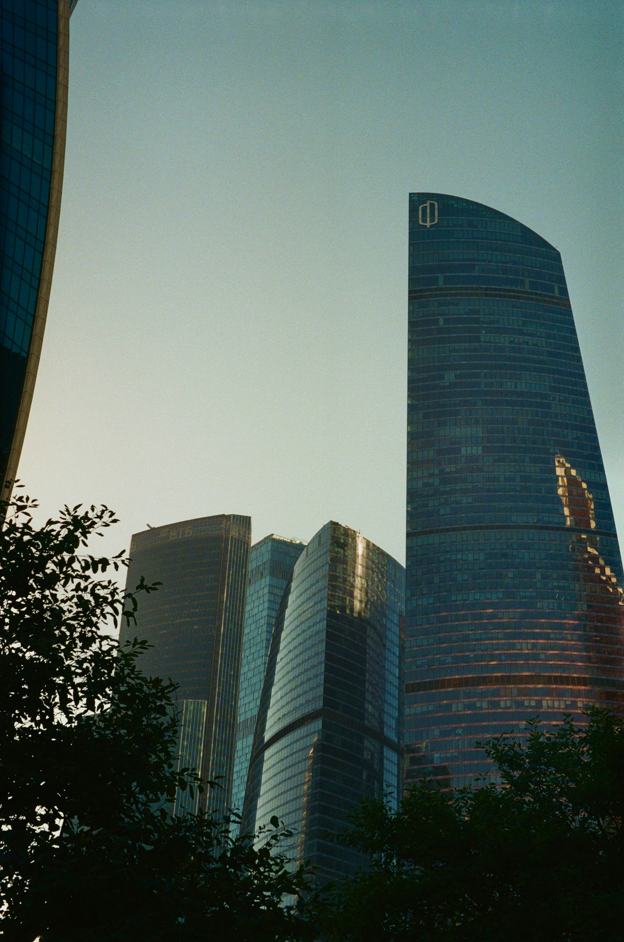 Skyscraper silhouettes against a pale morning sky