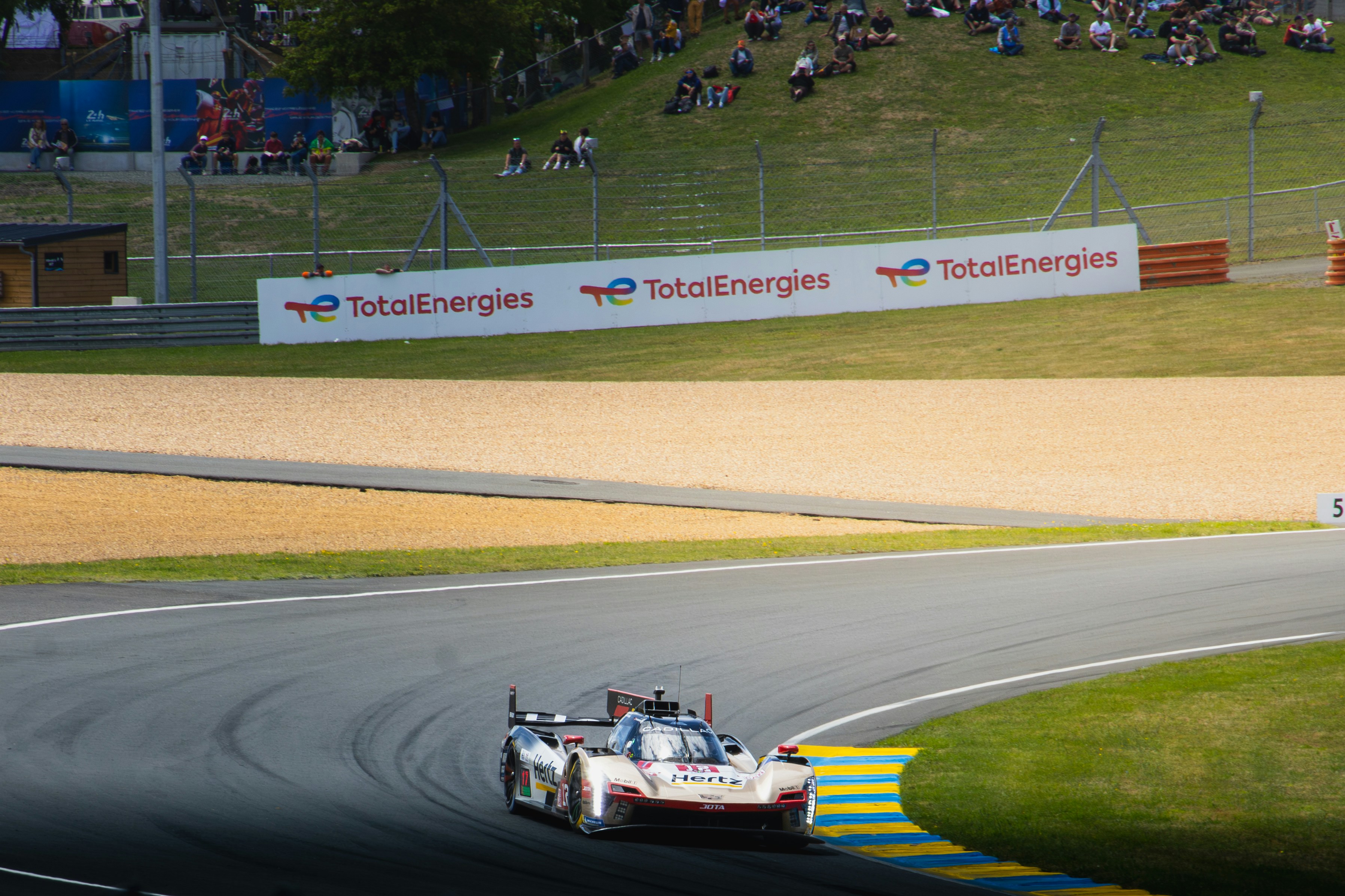 Chasing the Apex: Racecar Rounds the Bend under Stands