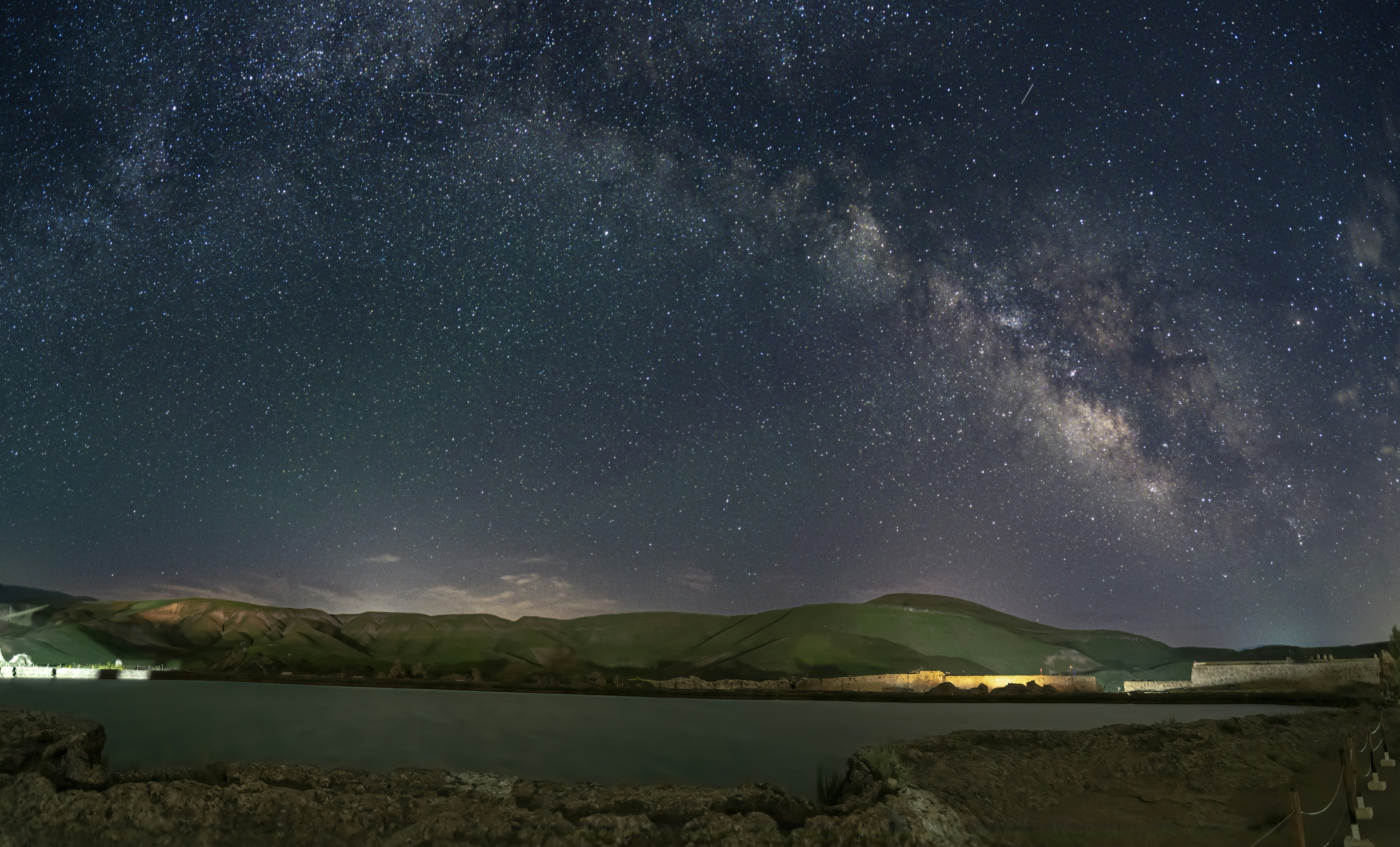 Milky Way over Quiet Shores: A Nightscape of Stars and Distant Lights