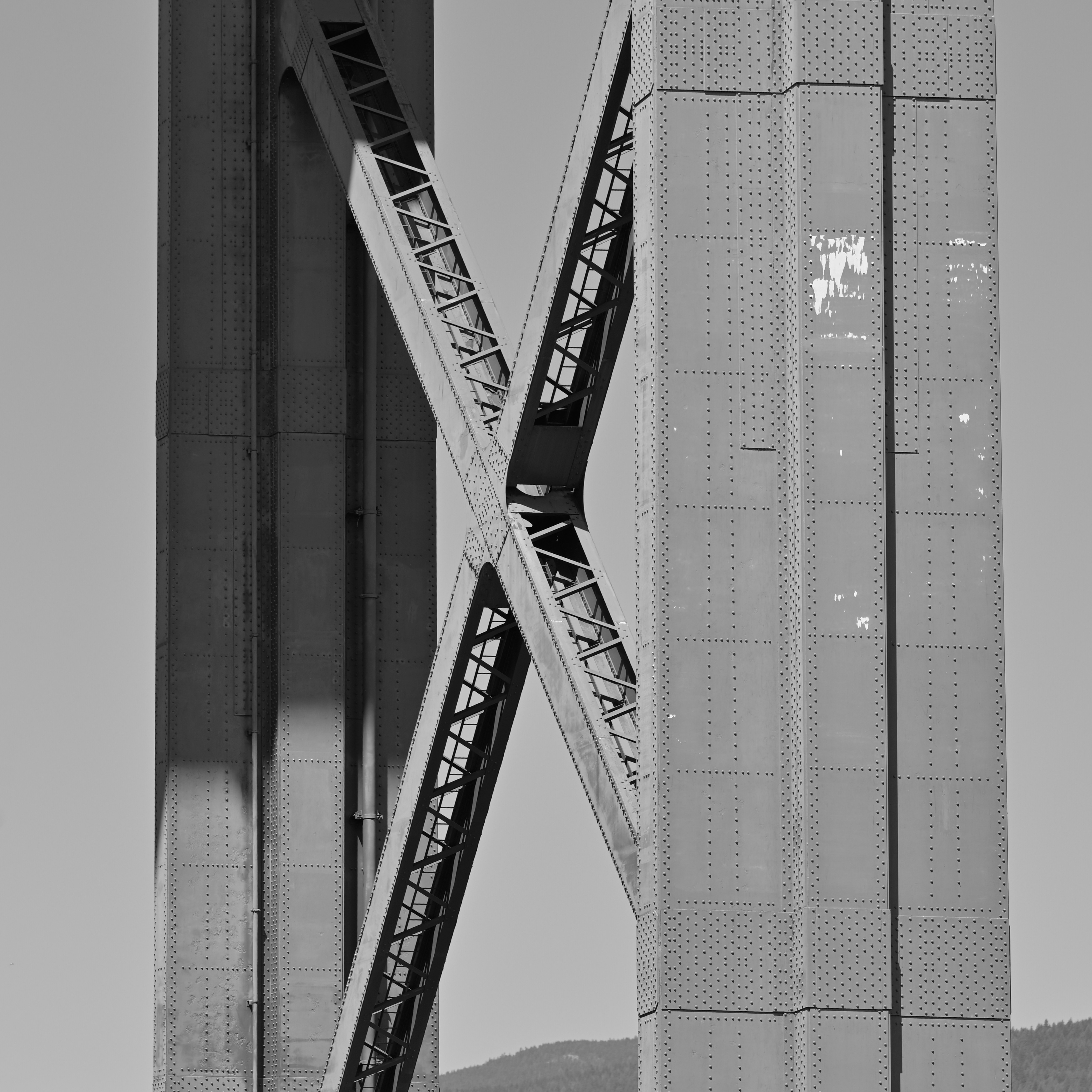 Crossing Struts: A Monochrome Moment Inside a Steel Span